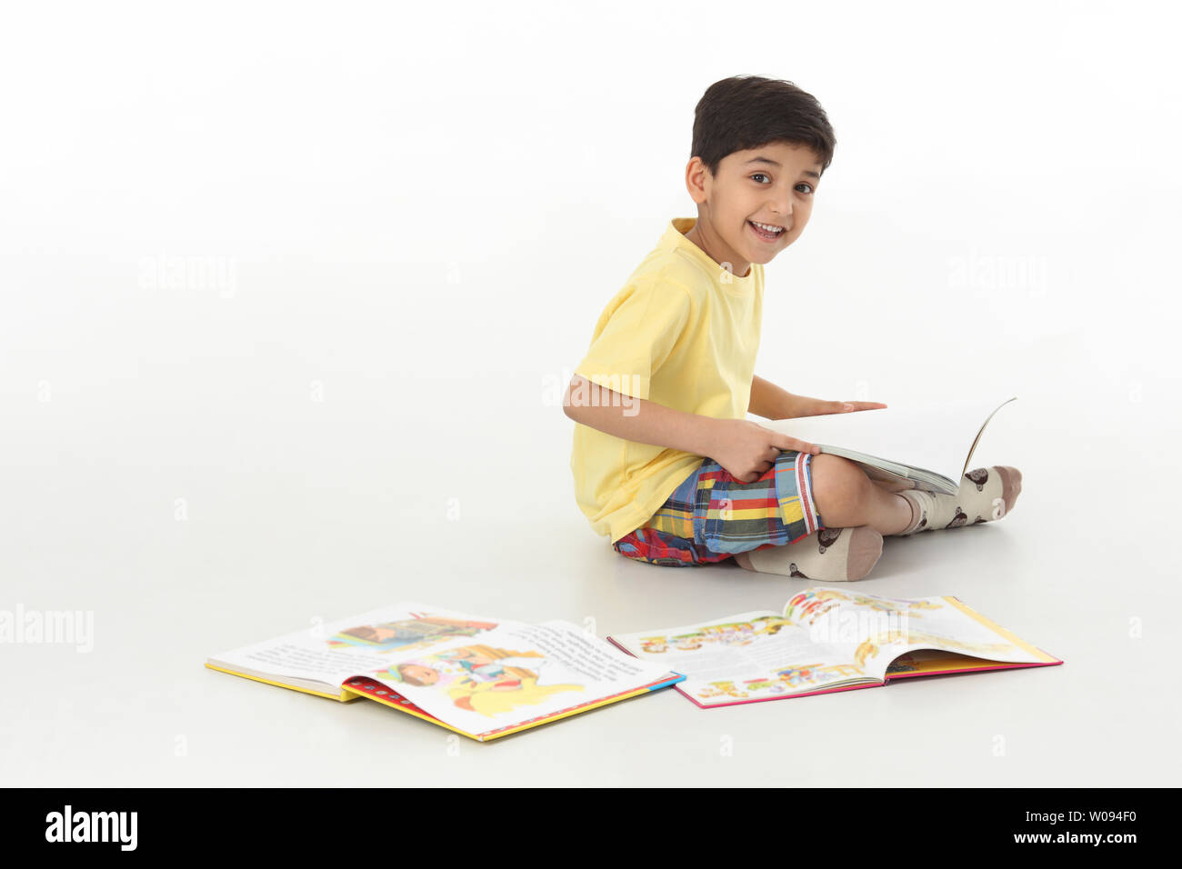 Boy reading a book Stock Photo - Alamy