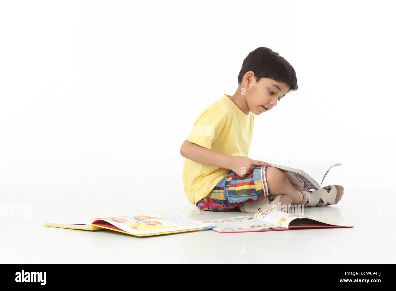 Boy reading a book Stock Photo - Alamy
