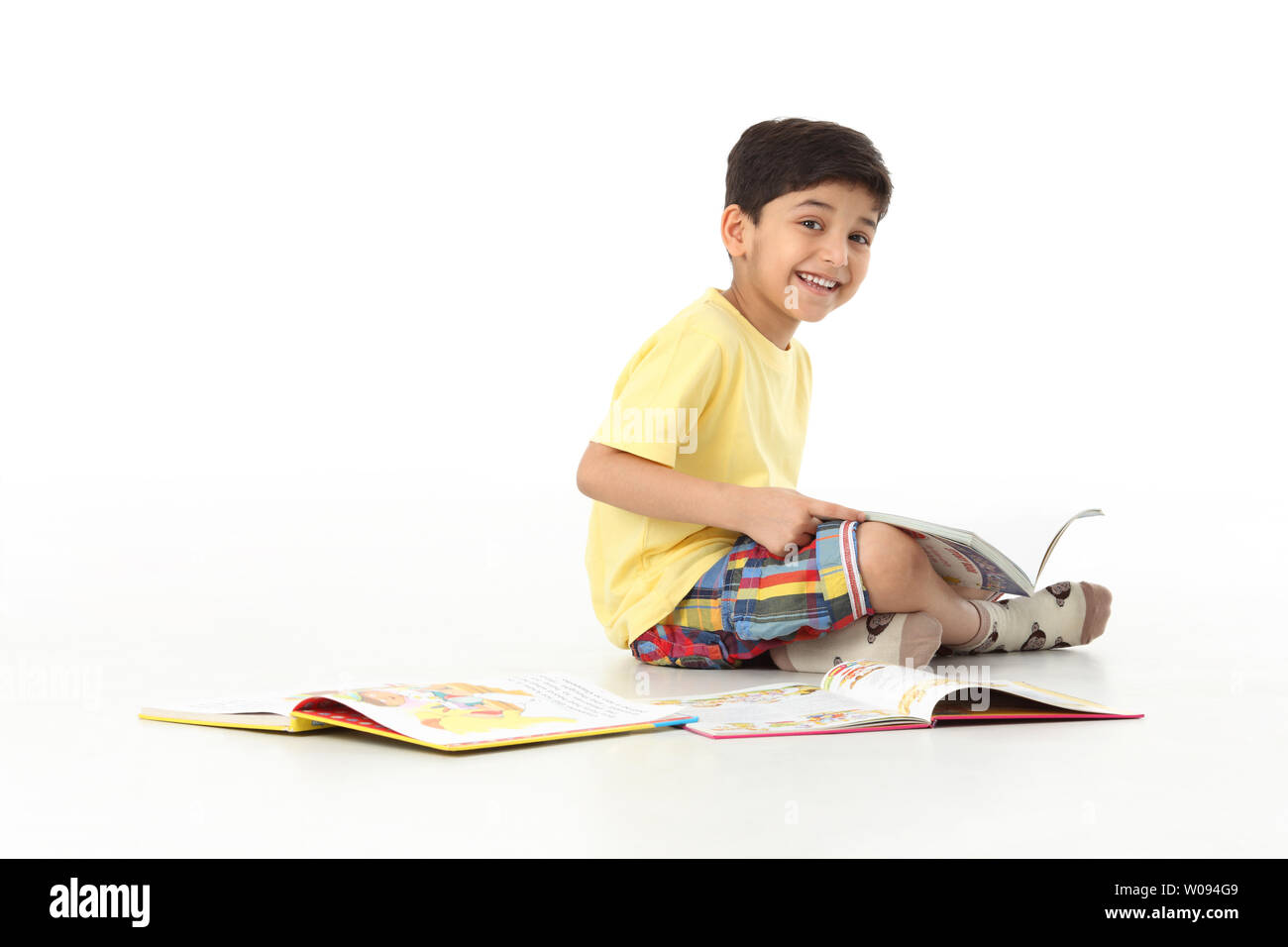 Boy reading a book Stock Photo - Alamy