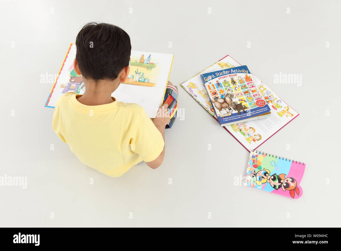Indian boy reading a book Stock Photo - Alamy