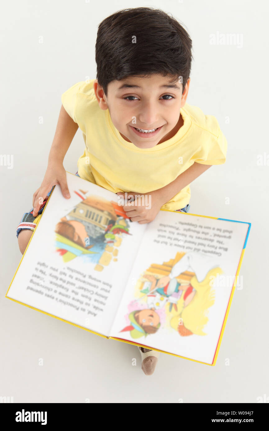 Indian boy reading a book Stock Photo - Alamy
