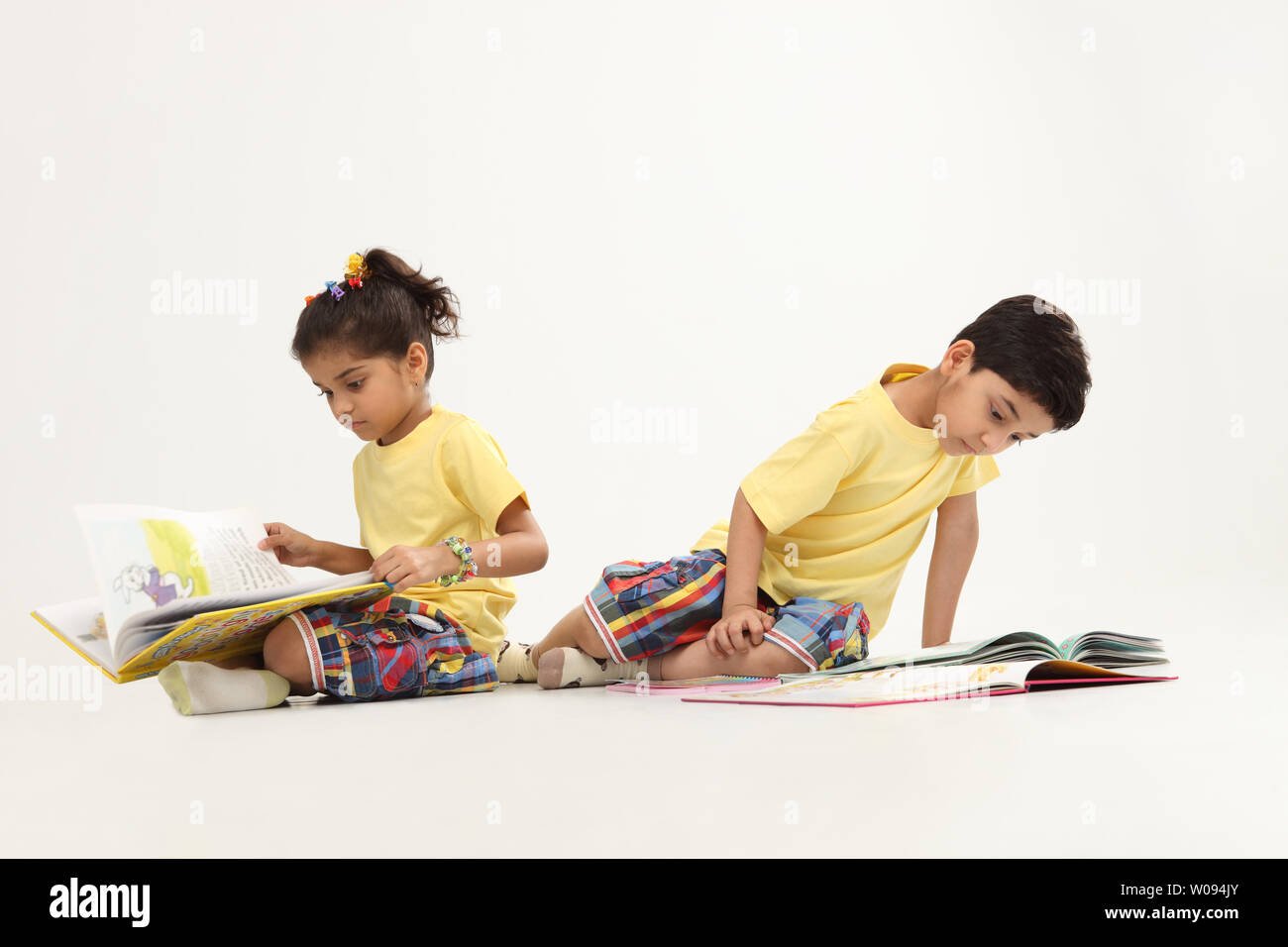 Two children reading books Stock Photo - Alamy