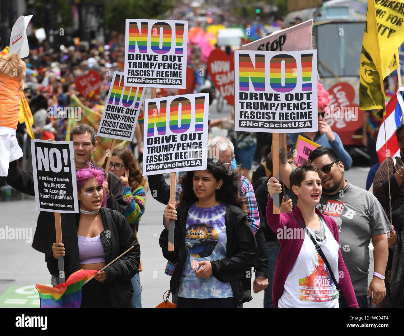 Political signs are carried in the annual LGBT Pride Parade in San ...