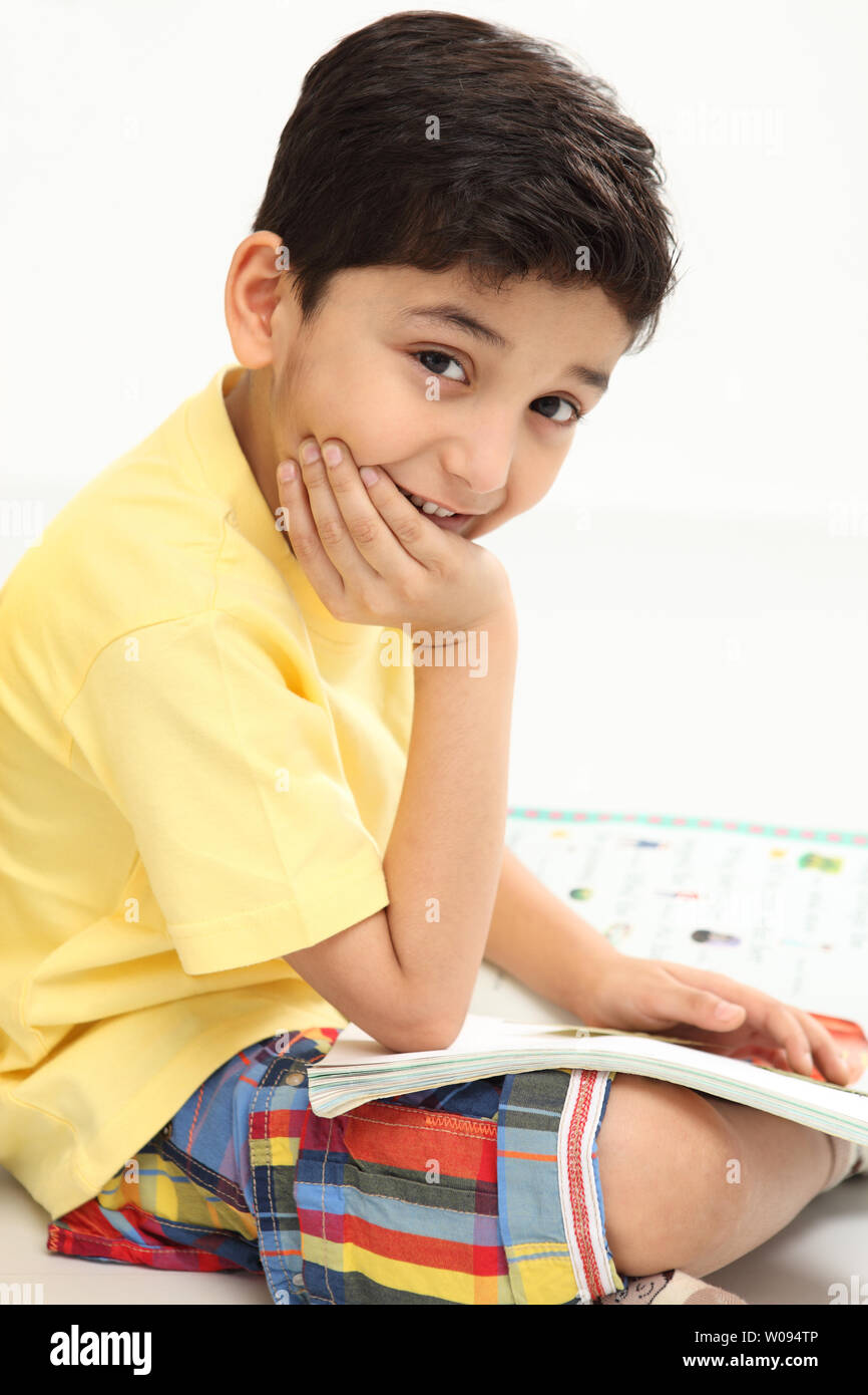 Indian boy reading a book Stock Photo - Alamy