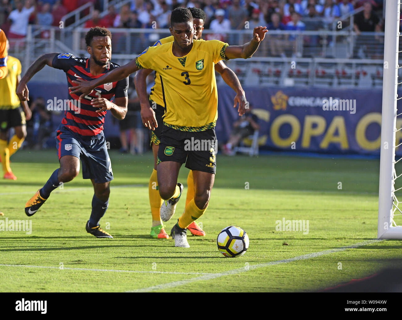 Jamaica's Damion Lowe (3) clears the ball away from USA's Kellyn Acosta ...