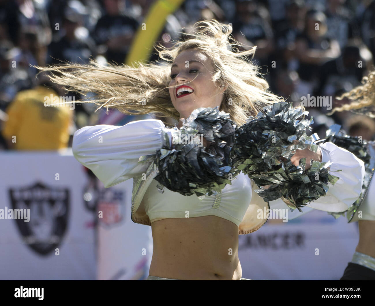 An Oakland Raiderette entertains as the Baltimore Ravens defeat the ...