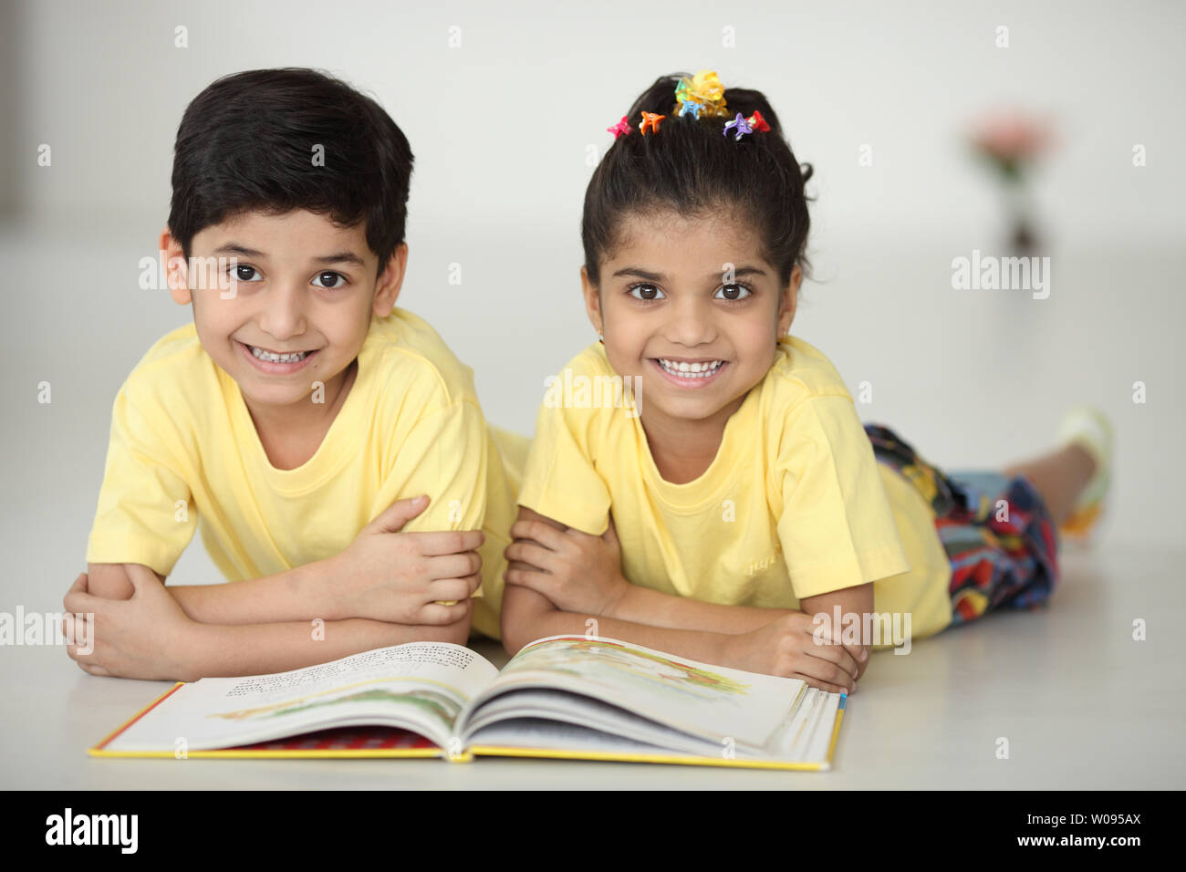 Two Indian children reading a book Stock Photo - Alamy