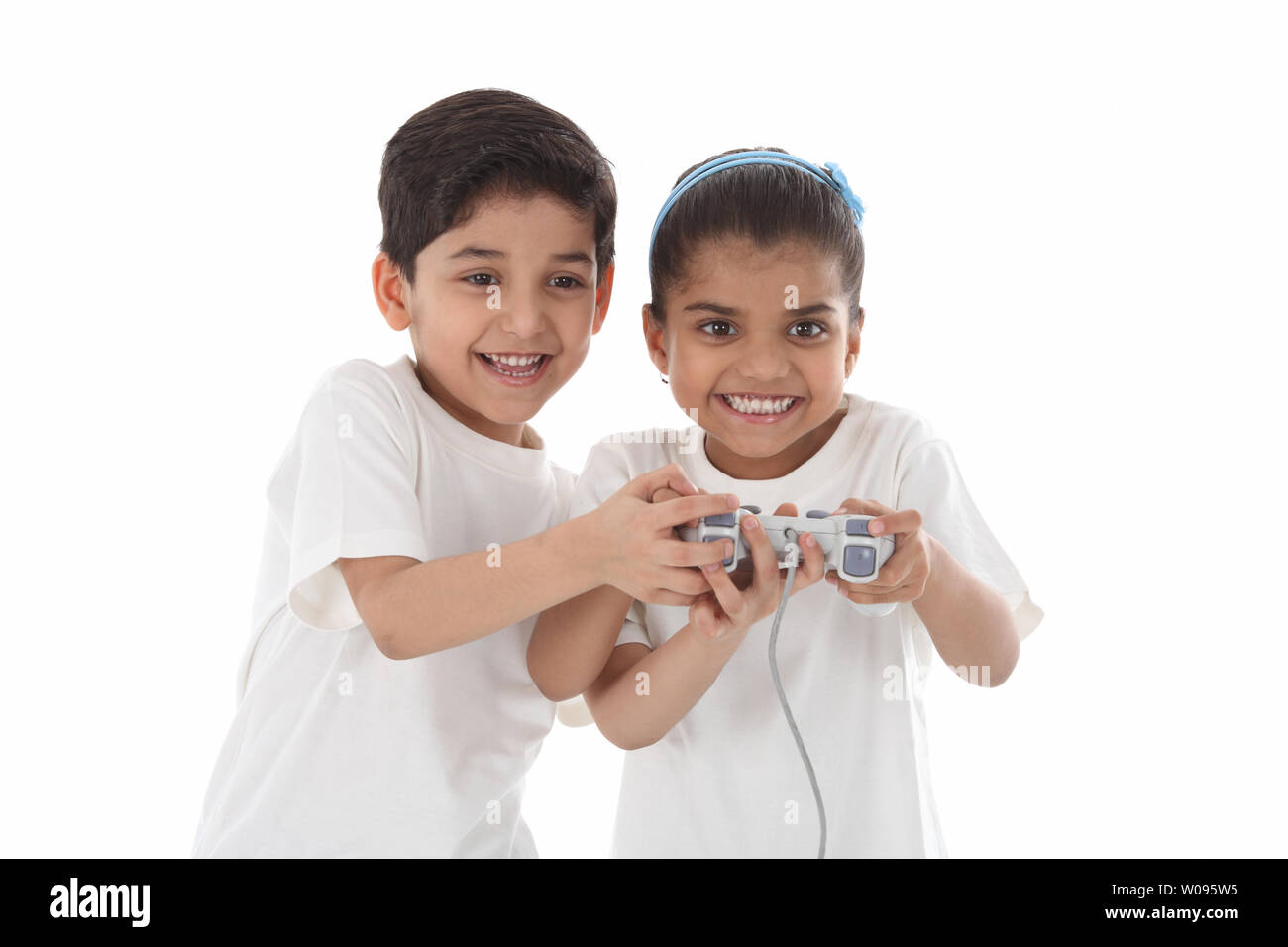 Two Indian children playing video gam Stock Photo - Alamy