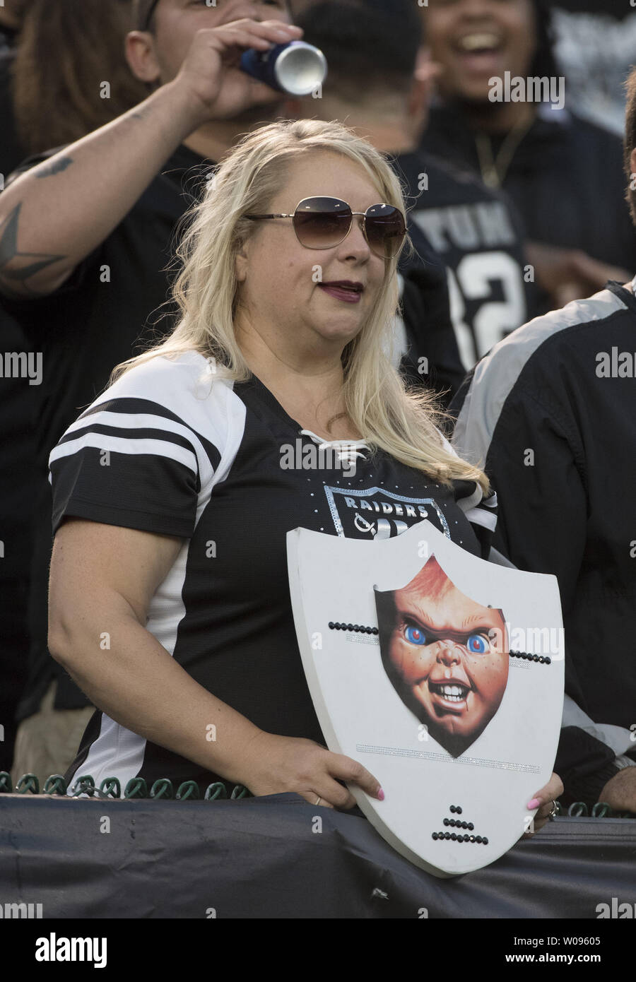 An Oakland Raiders fan holds a chucky shield for new head coach Jon ...