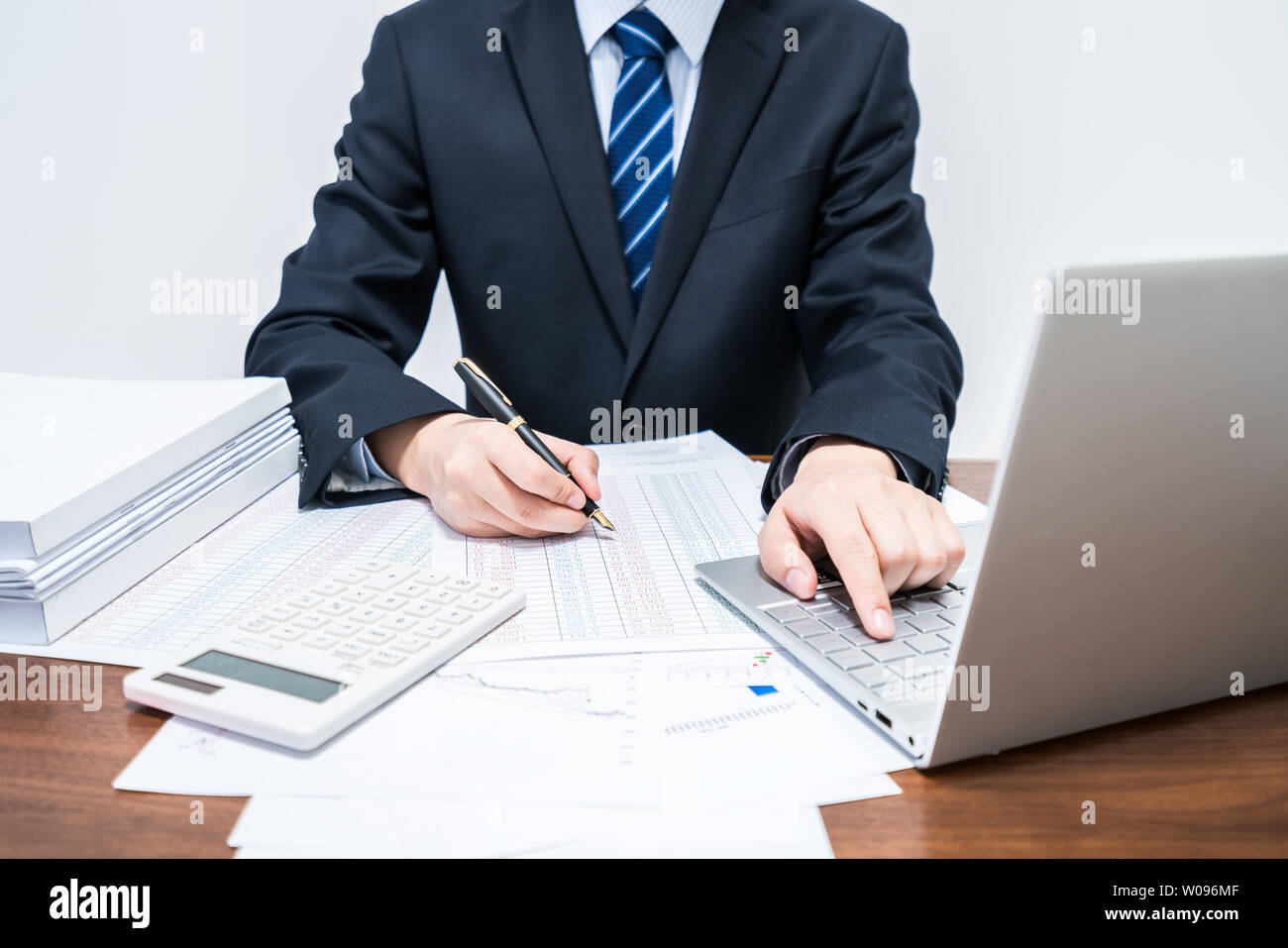 Businessman using computer accounting Stock Photo - Alamy