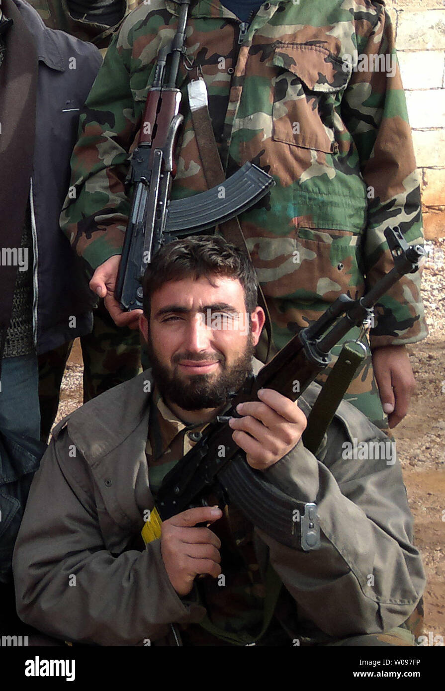 Opposition Syrian Free Army members hold their guns as they attend a ...
