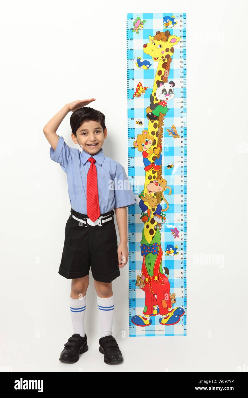 Portrait of a schoolboy measuring his height Stock Photo - Alamy