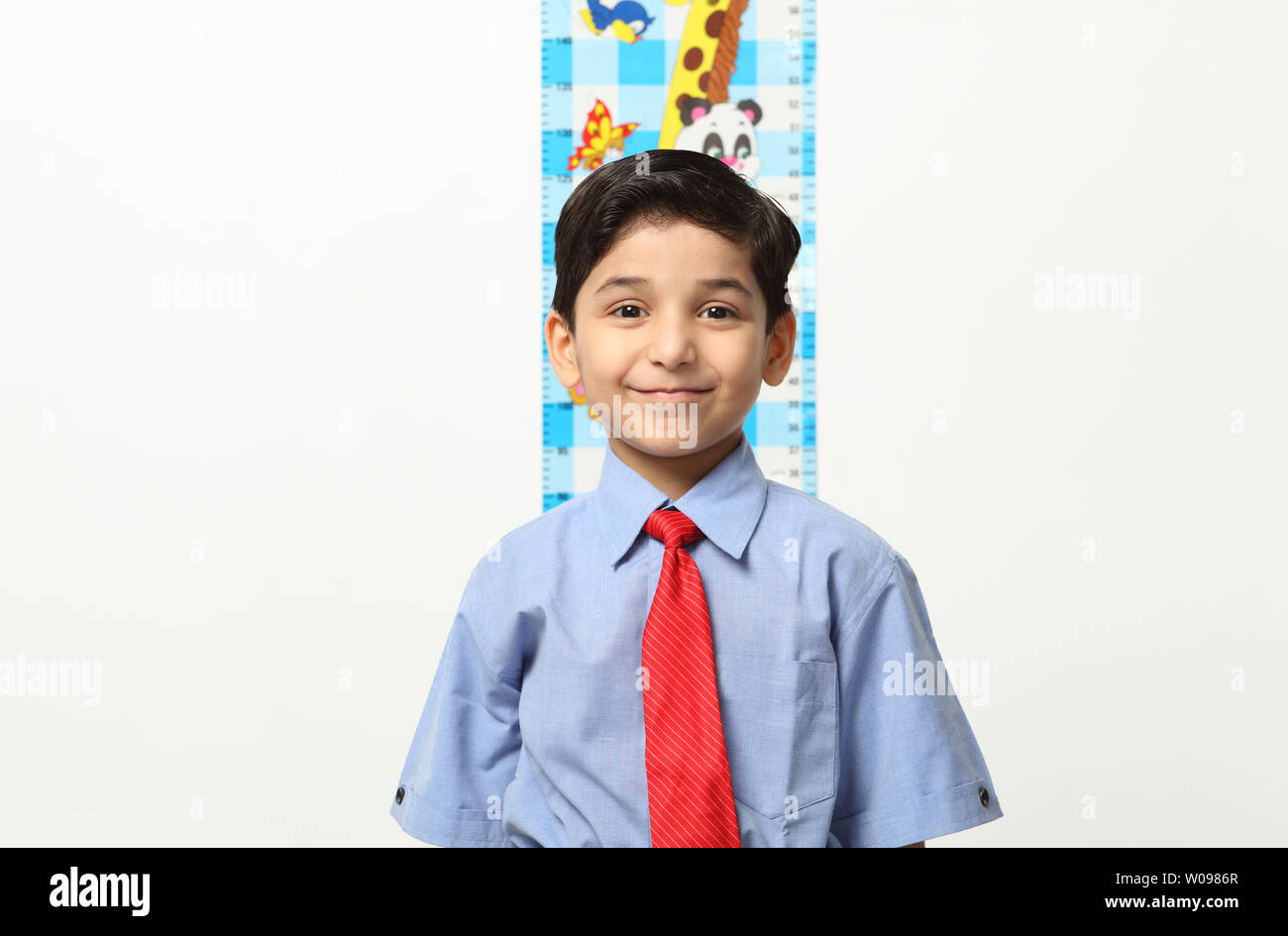 Portrait of an Indian schoolboy measuring his height Stock Photo - Alamy