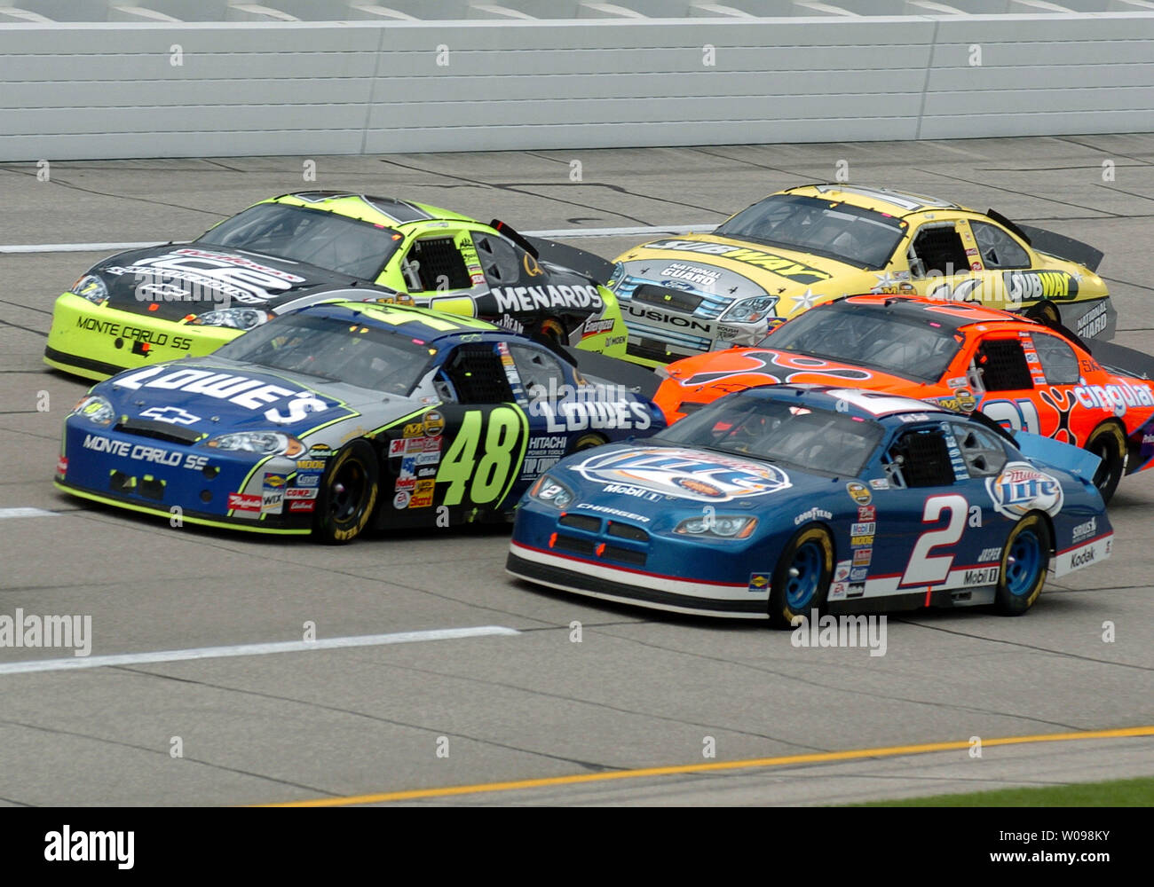 Race winner Jimmy Johnson (48) runs in a tight pack, surrounded by ...
