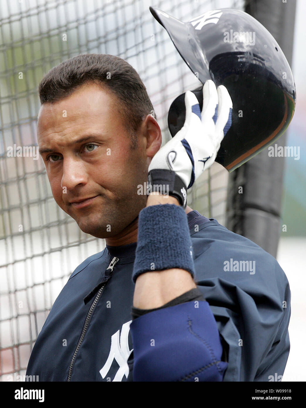 New York Yankees Derek Jeter flips off his helmet after taking batting ...