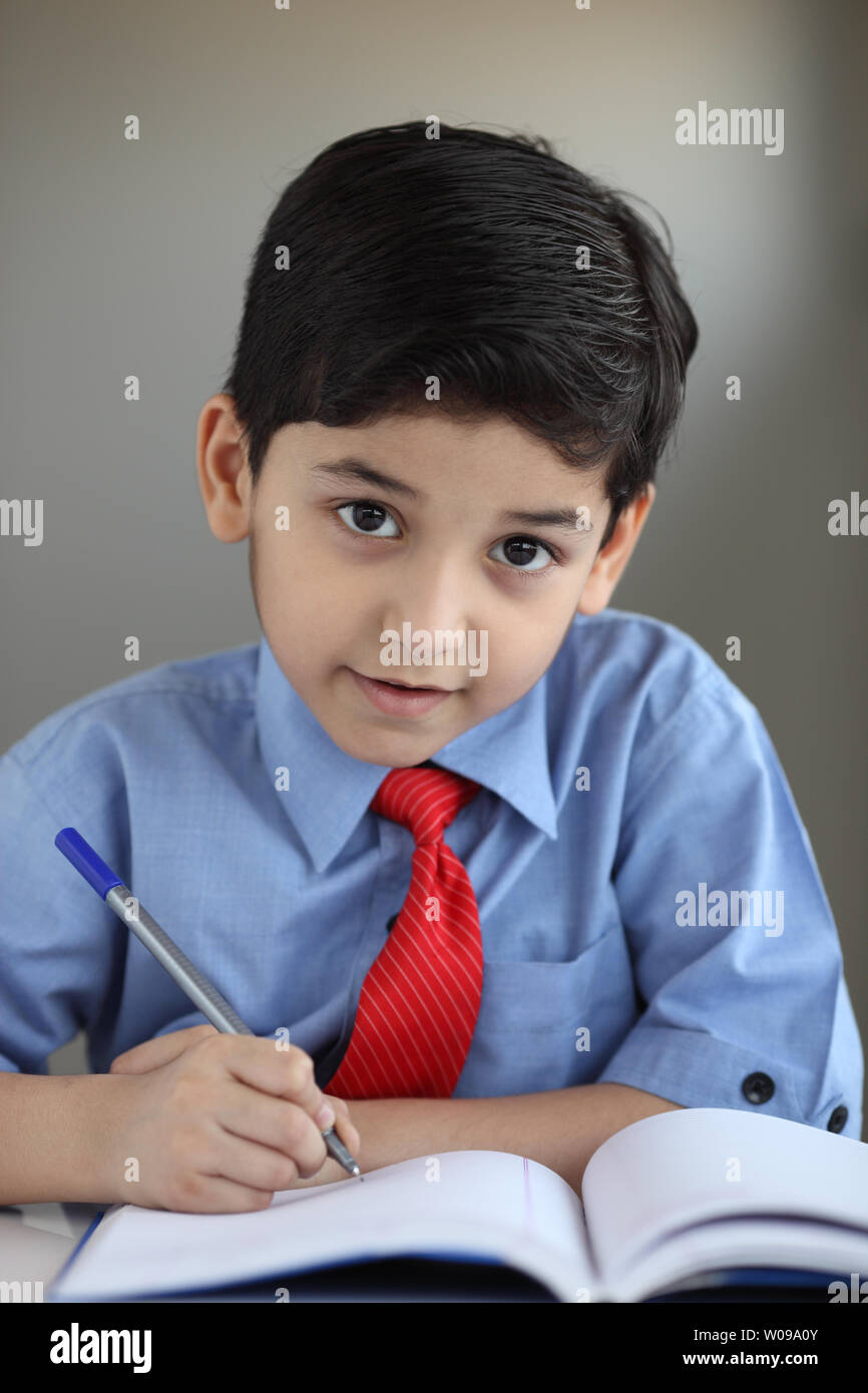 Portrait of an Indian schoolboy studying in classroom Stock Photo - Alamy