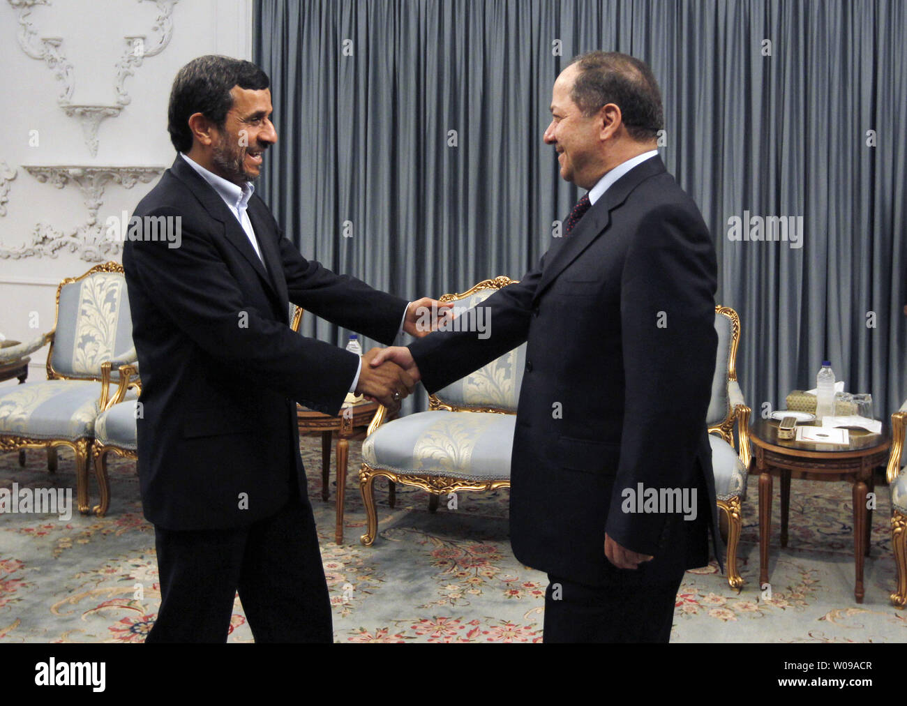 Iranian President Mahmoud Ahmadinejad (L) greets Masoud Barzani, the ...