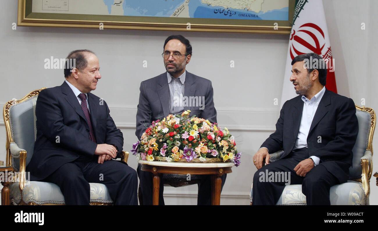 Iranian President Mahmoud Ahmadinejad (R) speaks with Masoud Barzani ...
