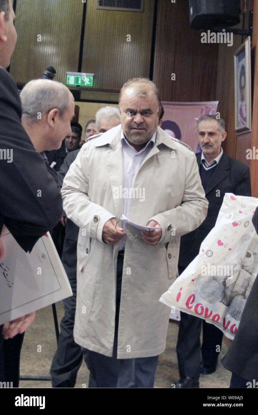 Iranian Oil Minister Rostam Qasemi (C) walks in to the press conference ...