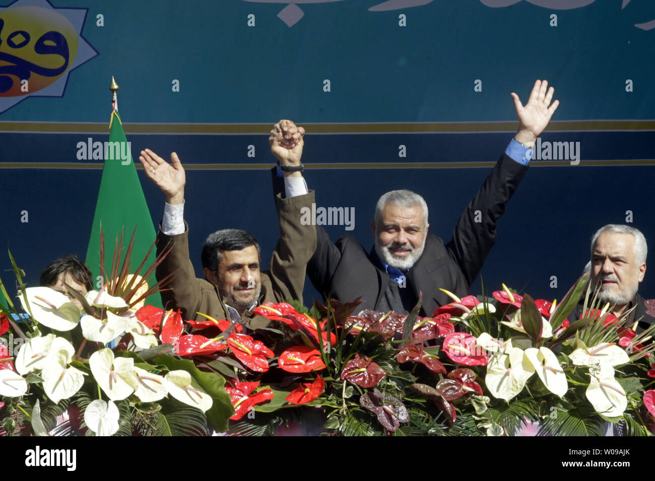 Iranian President Mahmoud Ahmadinejad (L) hold hands with Hamas Leader ...