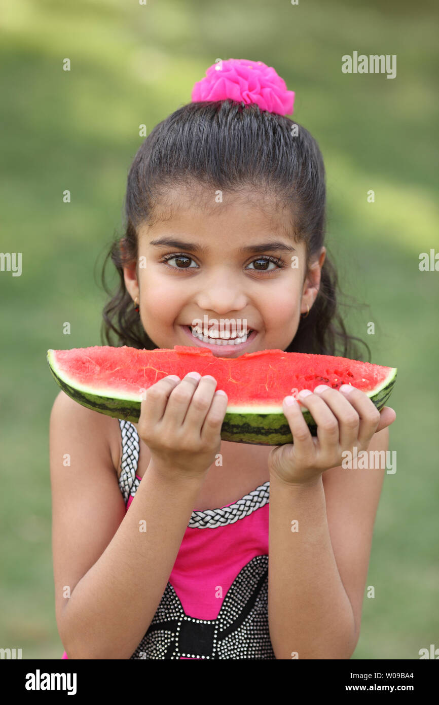 Portrait of a girl eating watermelon Stock Photo - Alamy