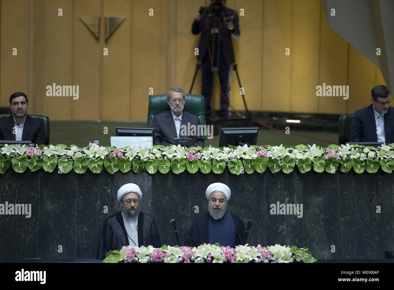 Iranian President Hassan Rouhani (R) stands next to judiciary chief ...