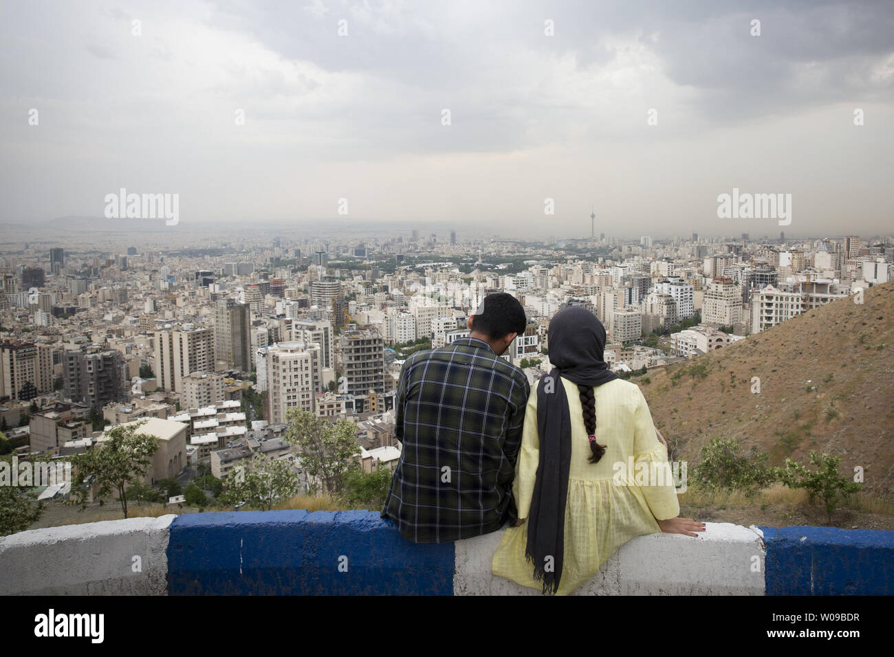 An Iranian couple enjoy the view at Bame Tehran (Roof of Tehran) in the ...