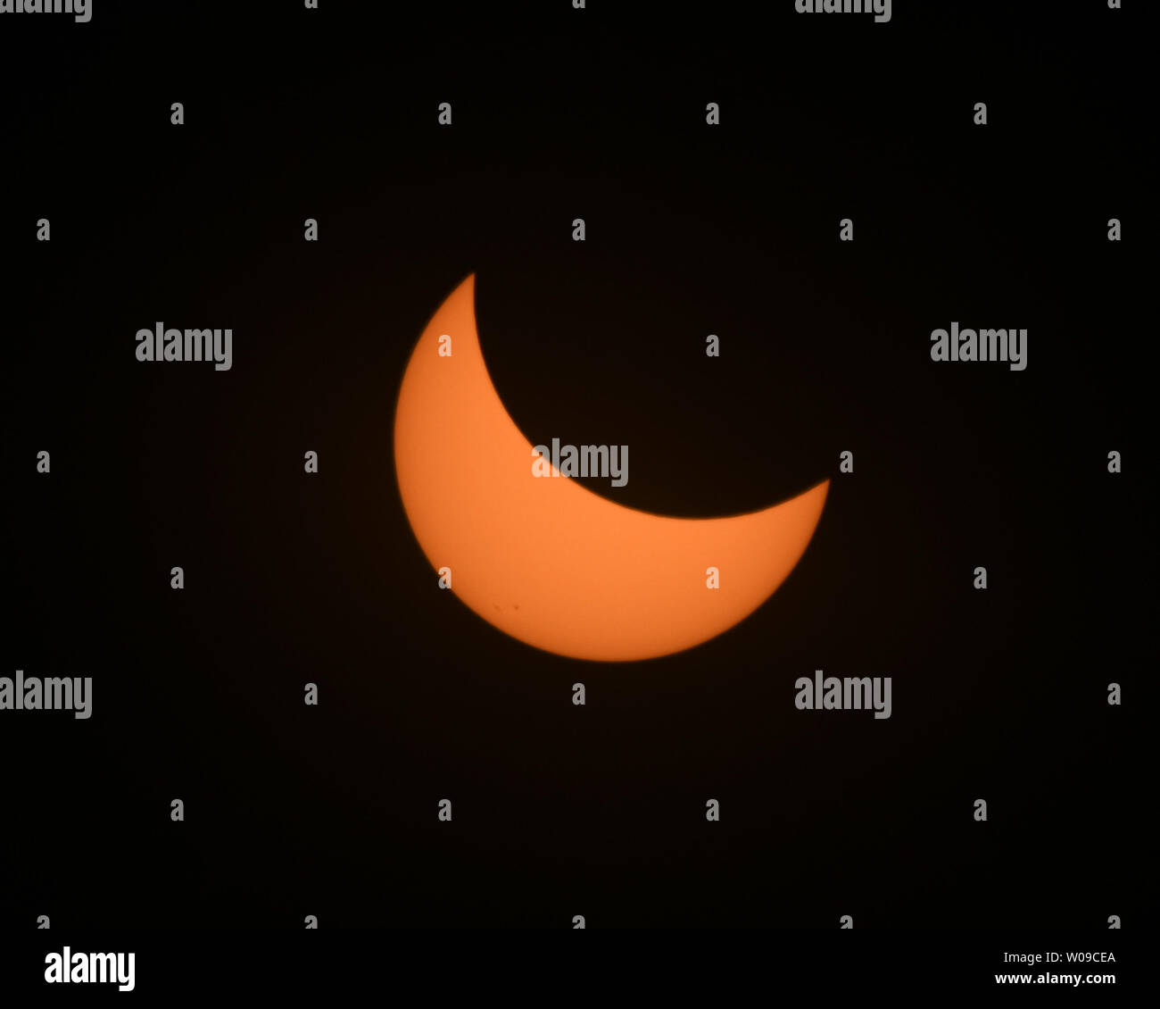 The moon blocks part of the sun as it orbits the earth creating a Total ...