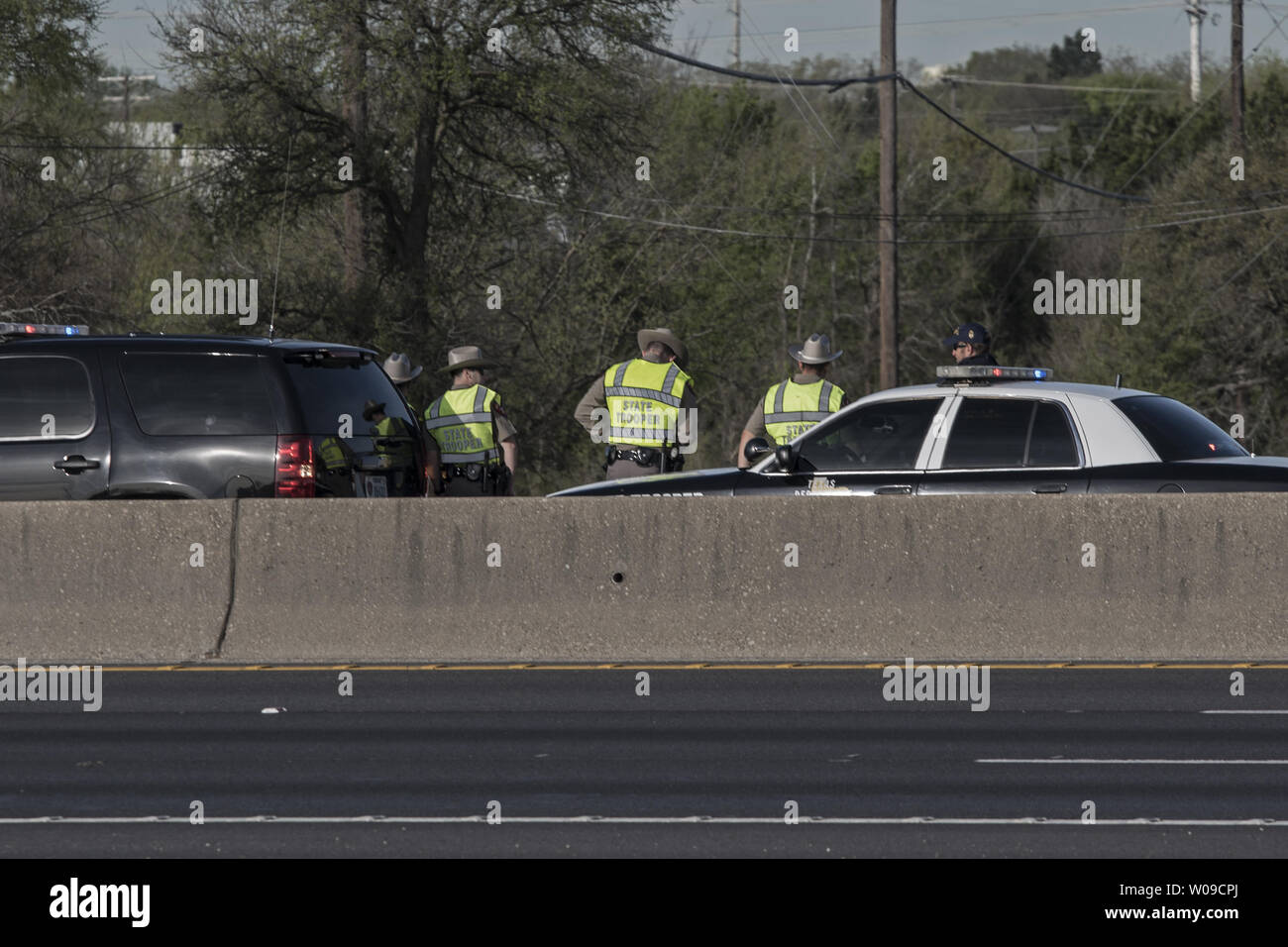 Law enforcement and emergency vehicles block the scene where suspected ...