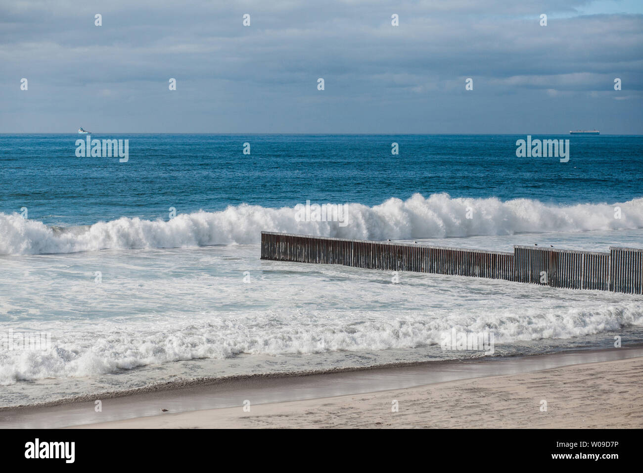 The border wall extends into the Pacific Ocean dividing Las Playas de ...