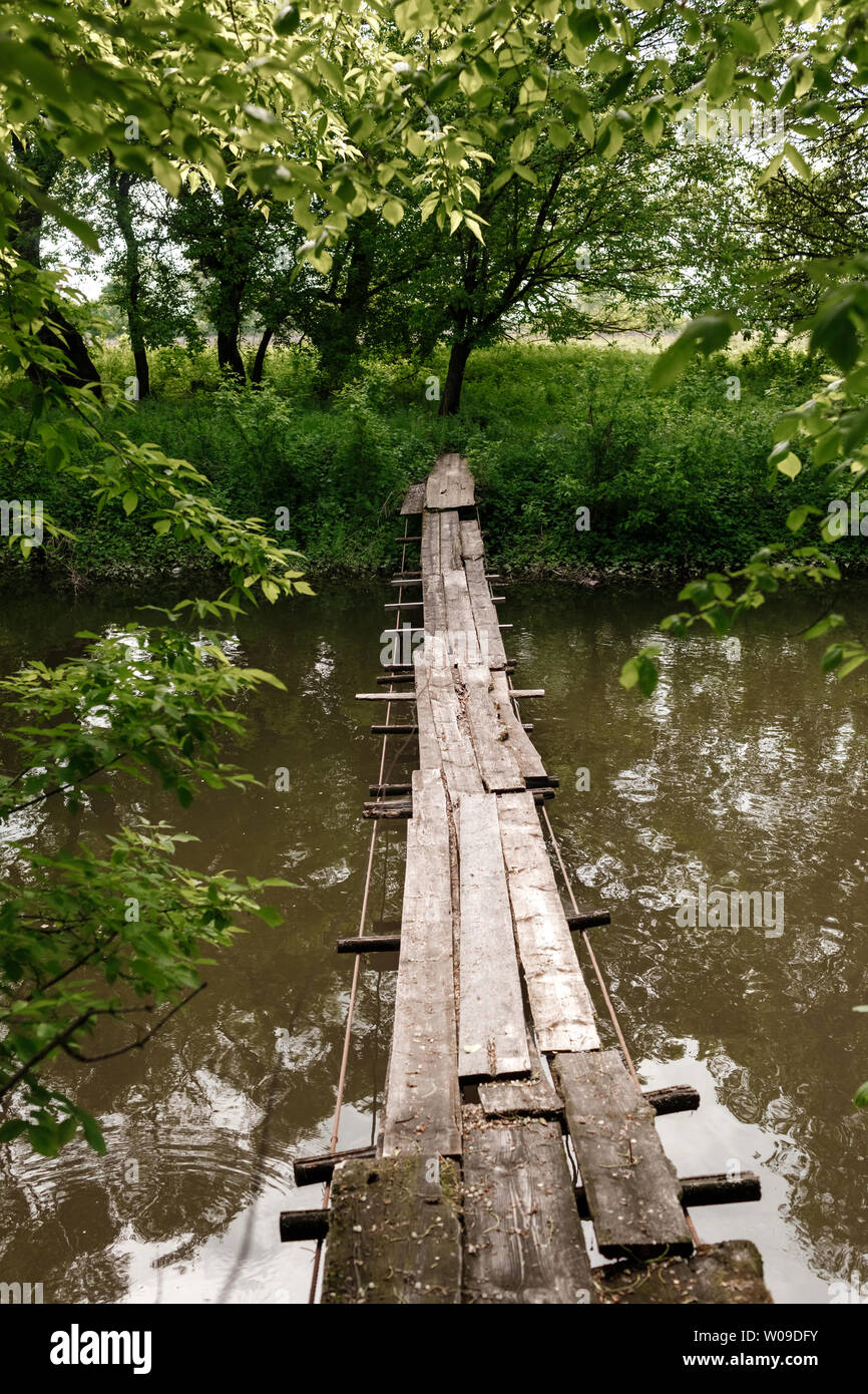 wooden bridge across the river. Old wooden bridge, wooden bridge across ...