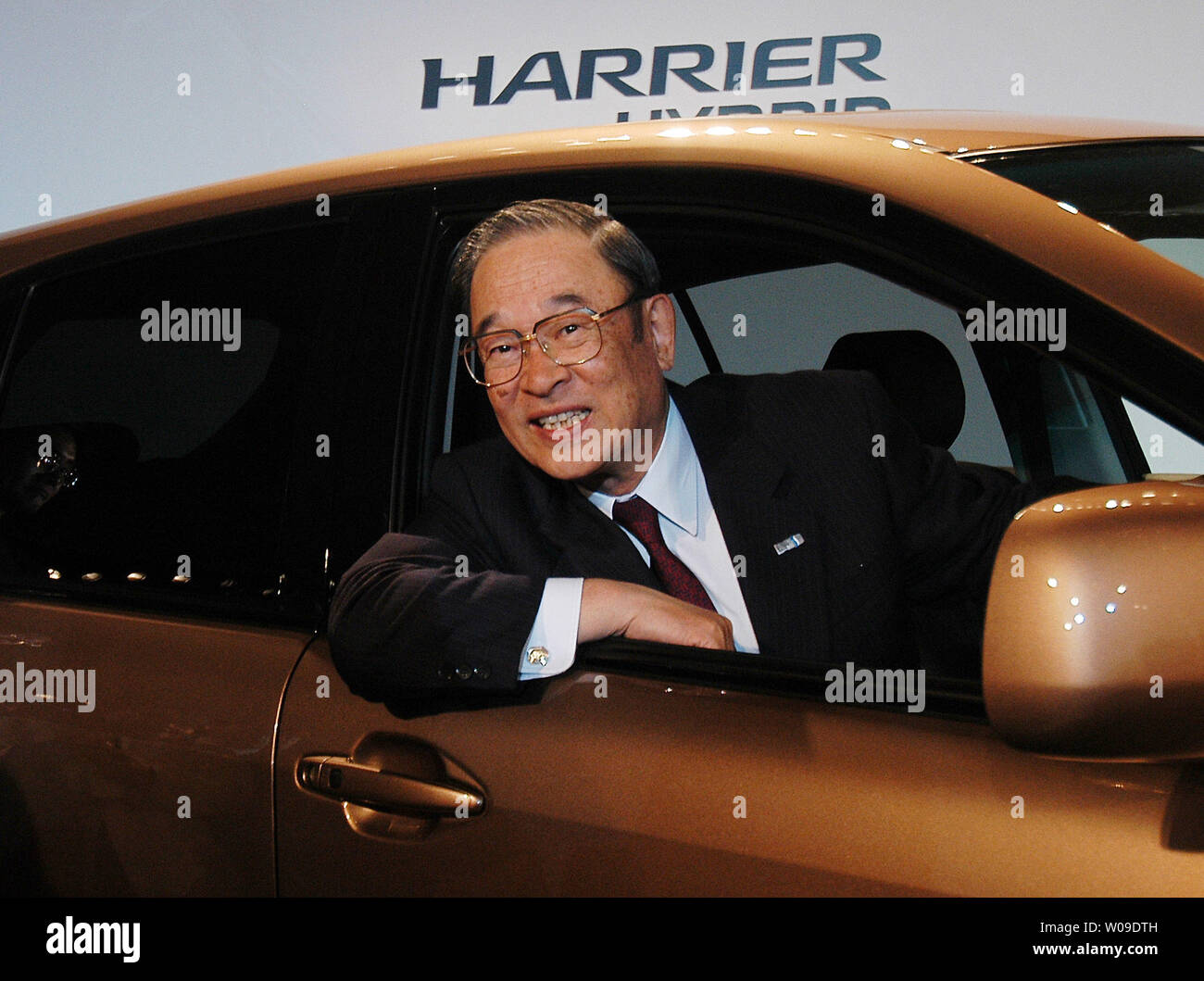 Fujio Cho, president of Toyota Motor Corporation grins from behind the ...