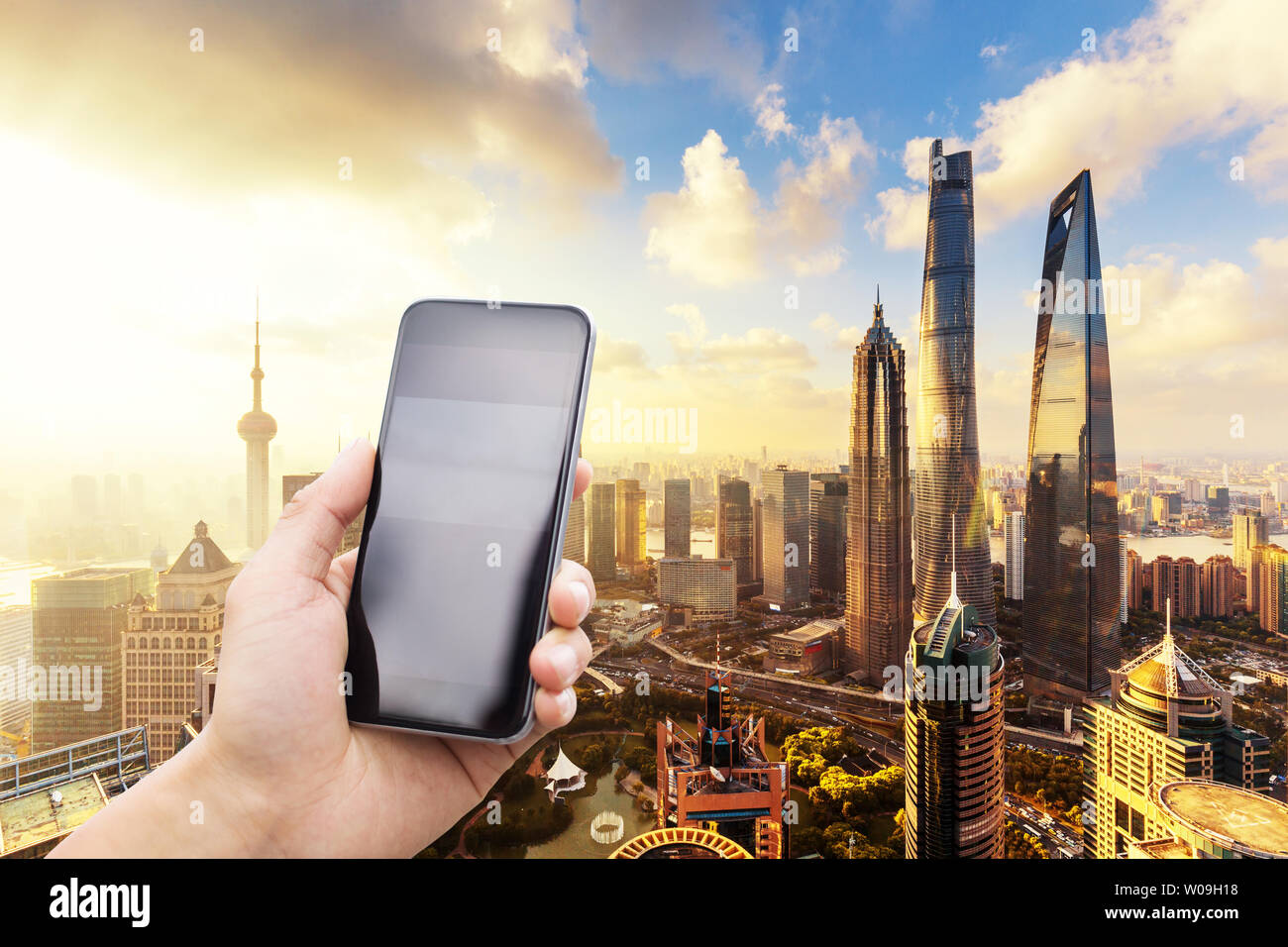 mobile phone with modern buildings at sunrise Stock Photo - Alamy