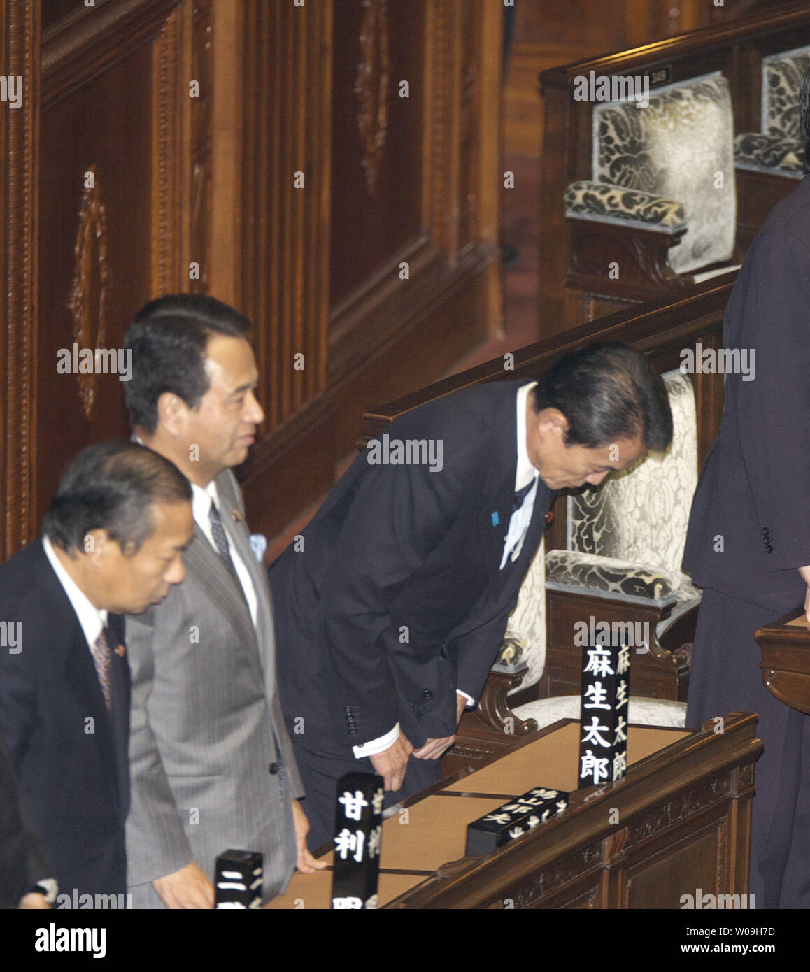 Japanese Prime Minister Taro Aso (R) bows to the lower house of the ...