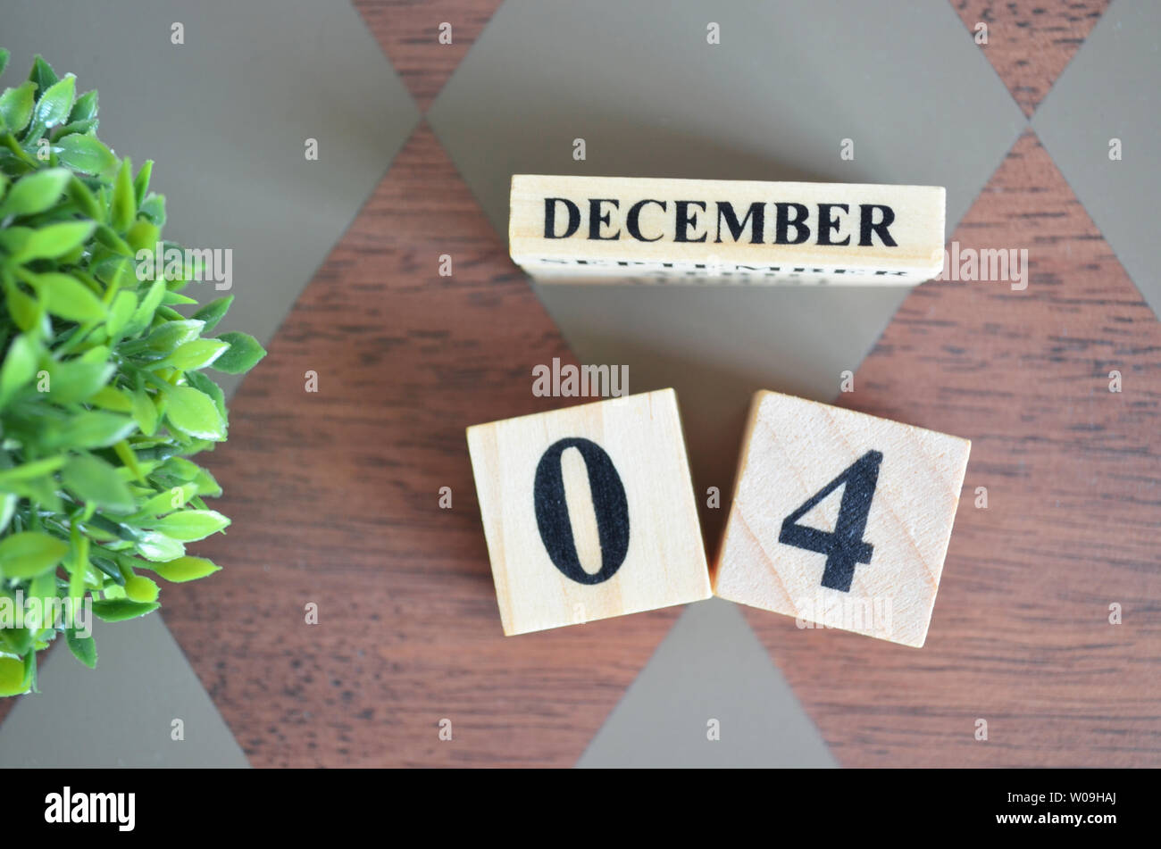 Date of December month with leaf on diamond pattern table for ...