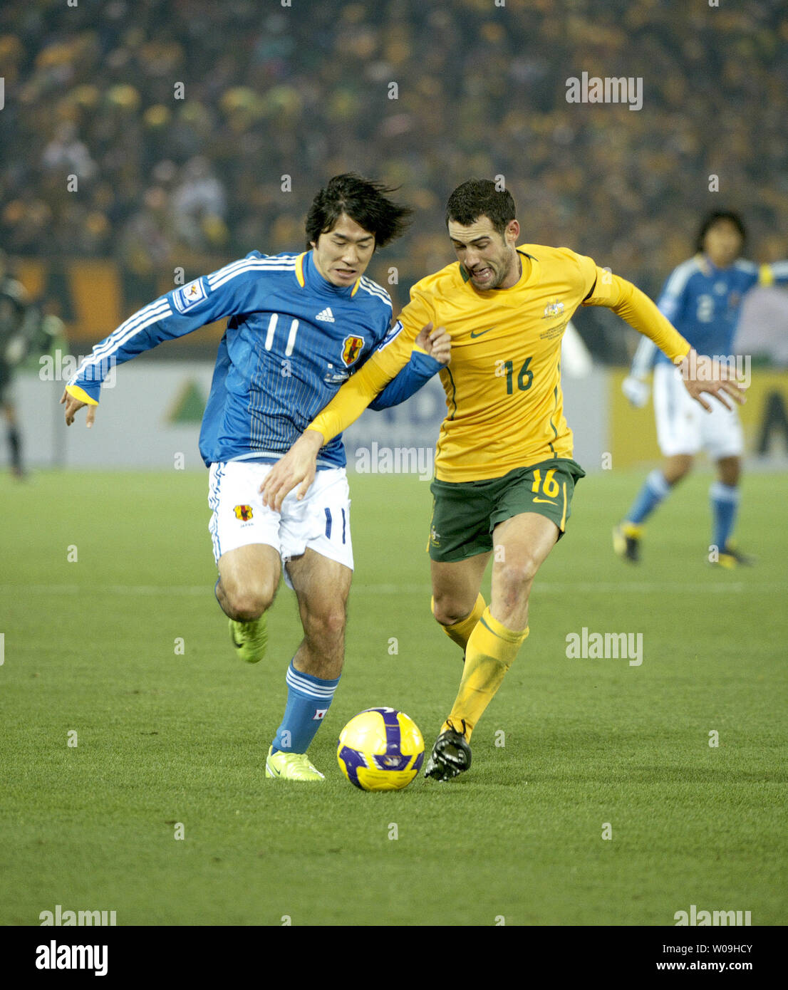 Keiji Tamada (L) of Japan and Carl Valeri of Australia battle for the ...