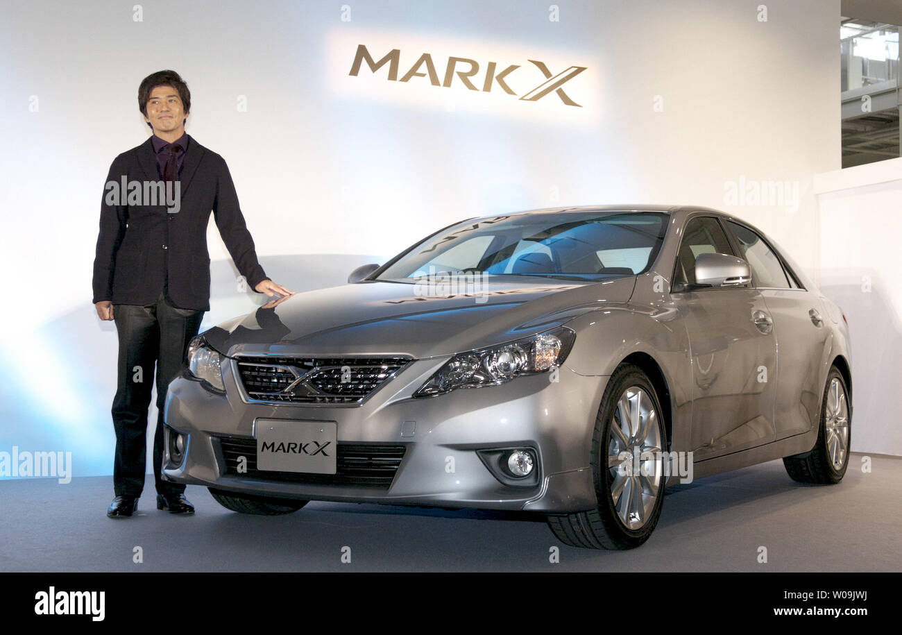 Japanese actor Koichi Sato poses with the redesigned Mark X luxury ...