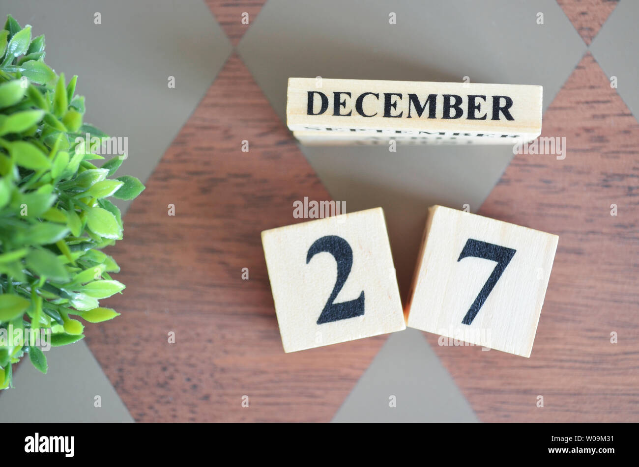 Date of December month with leaf on diamond pattern table for ...