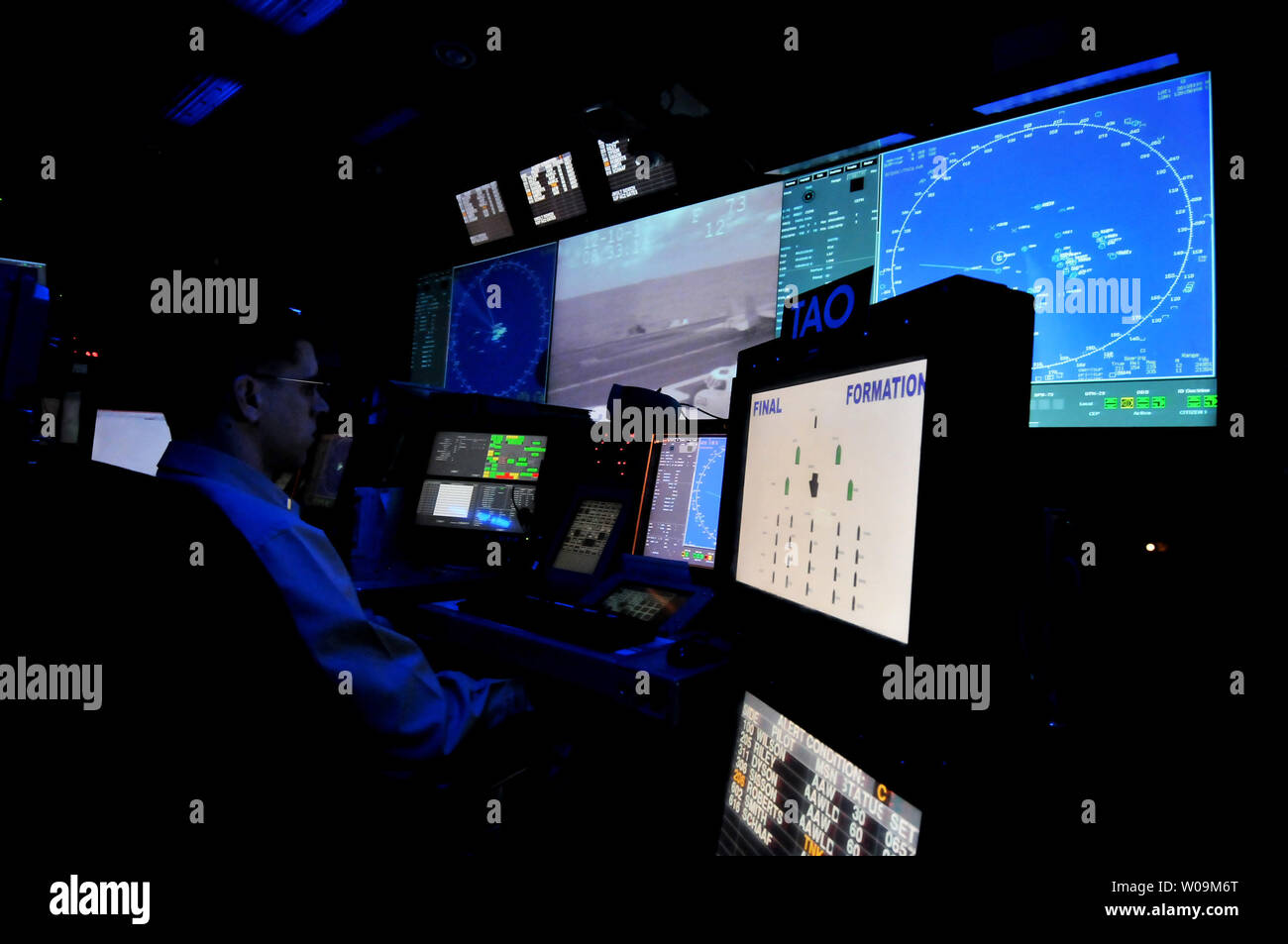 Staff watch radar screens in the CDC (Combat Direction Center) on the ...