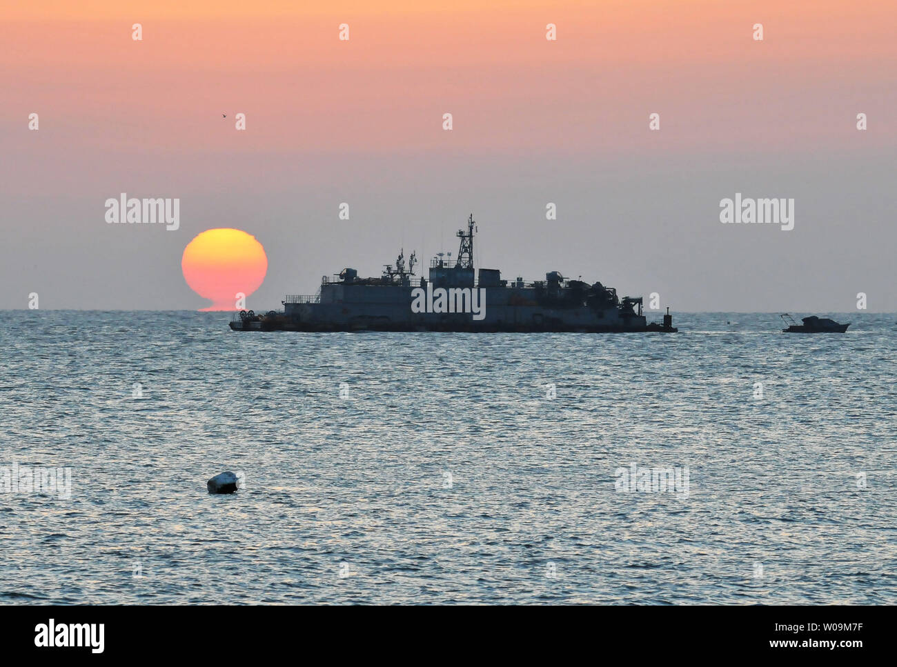 A South Korean Navy's floating base as the sun rises near Yeonpyeong ...