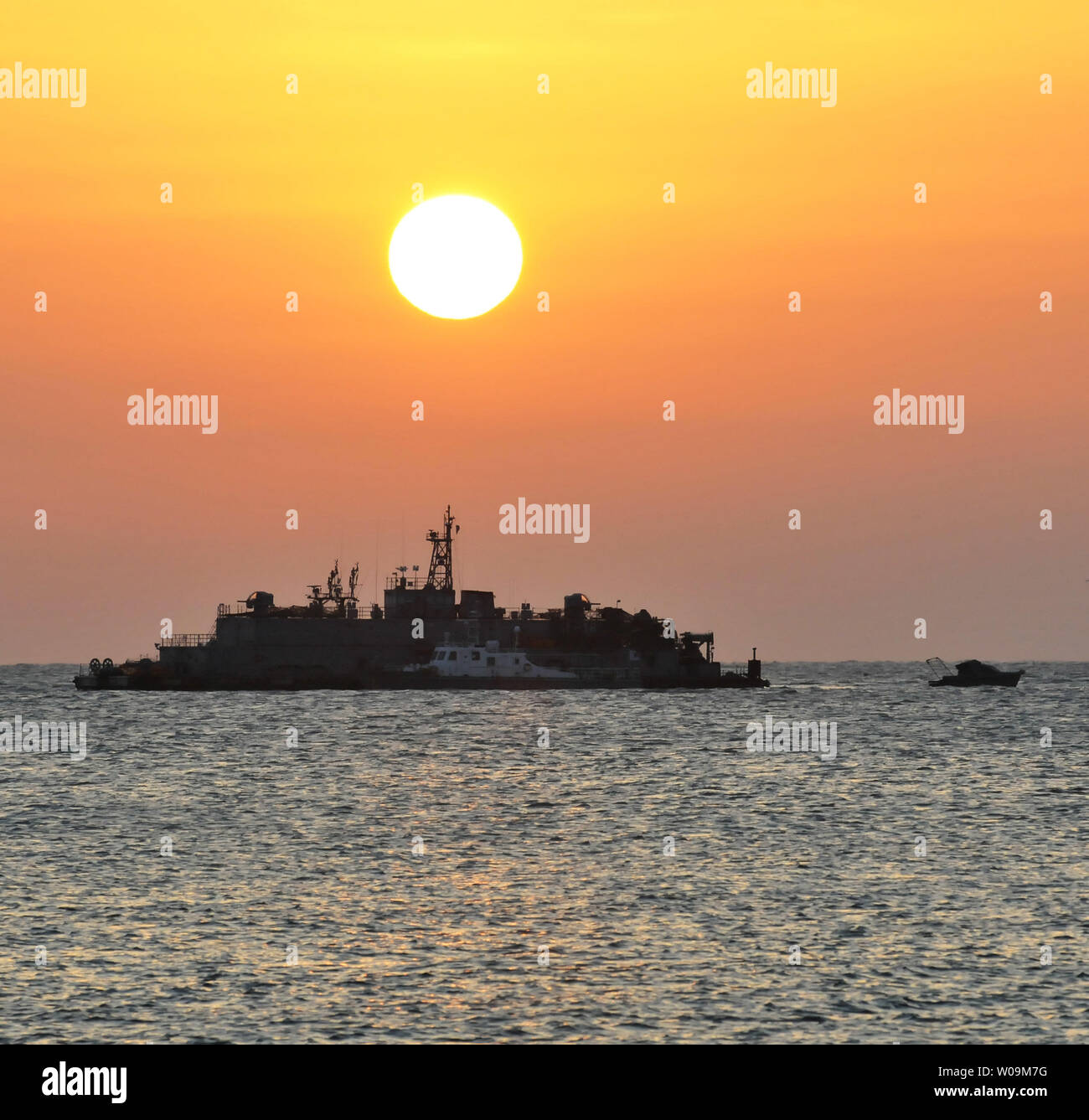 A Korea Coast Guard's ship sails past the South Korean Navy's floating ...