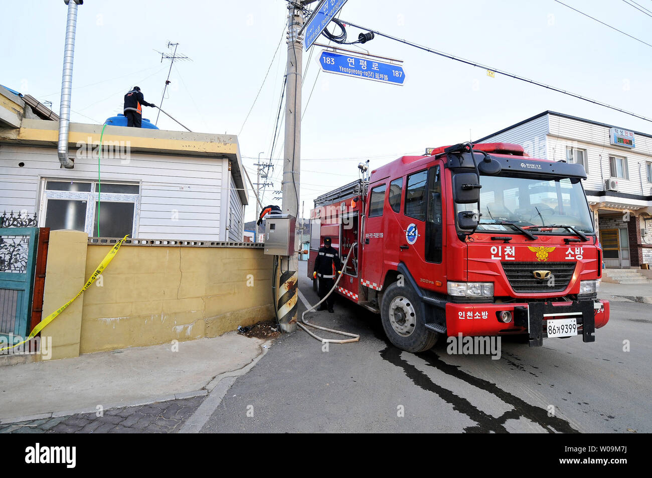 South Korean firefighters work on Yeonpyeong island, South Korea ...