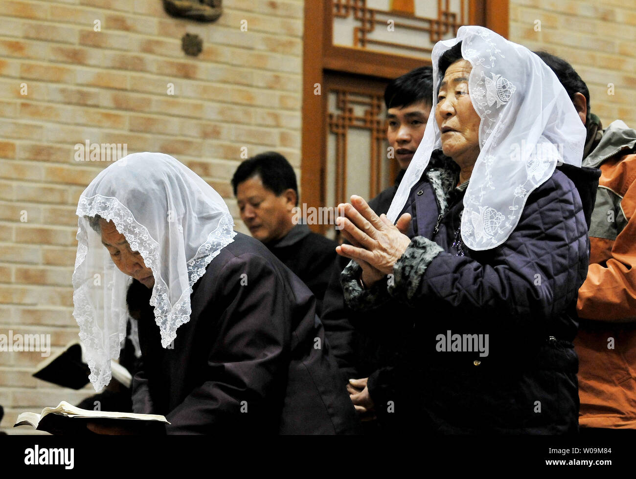 South Korean residents pray during Christmas mass on Yeonpyeong island ...