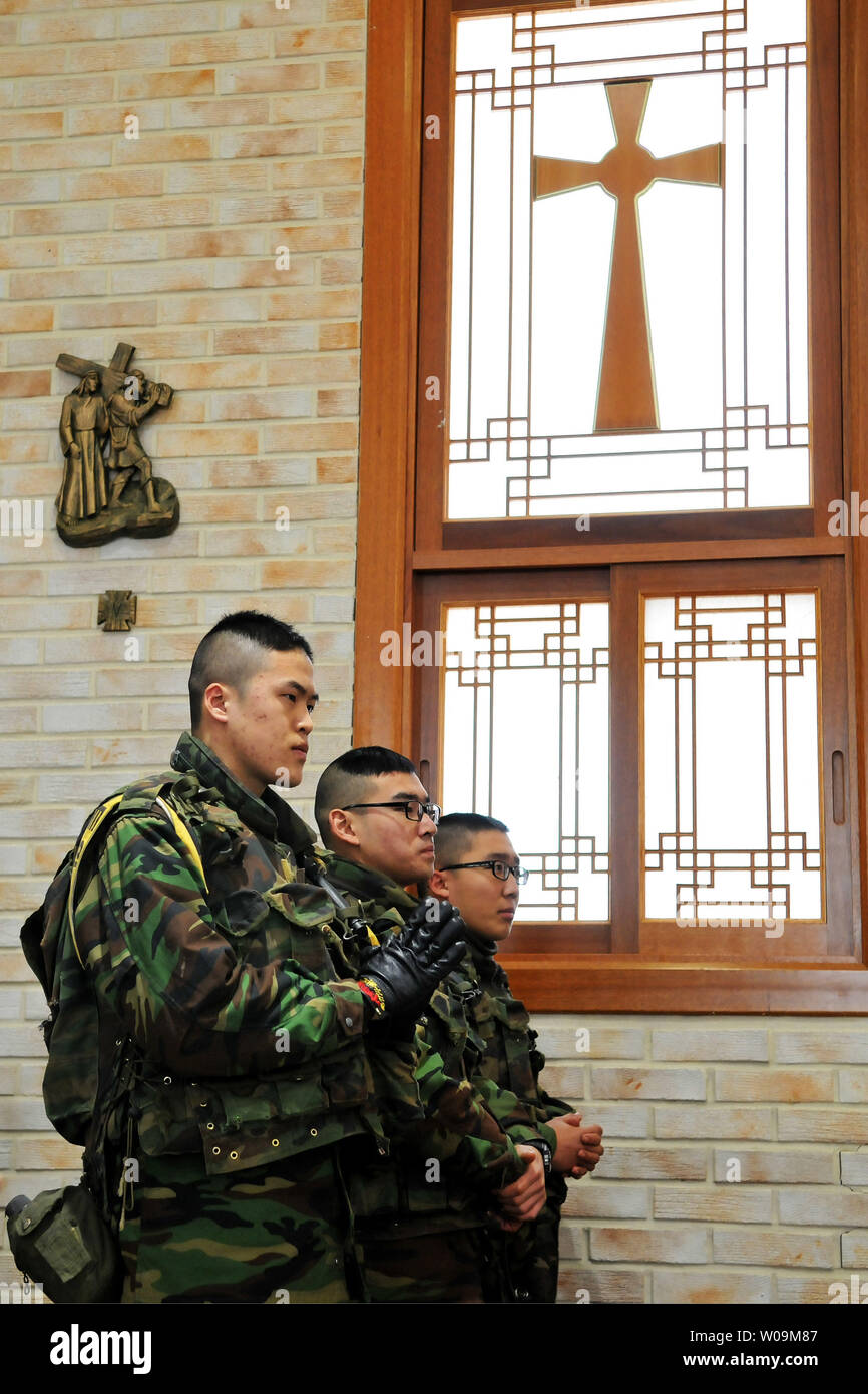 South Korean marines pray during worship at church on Yeonpyeong island ...