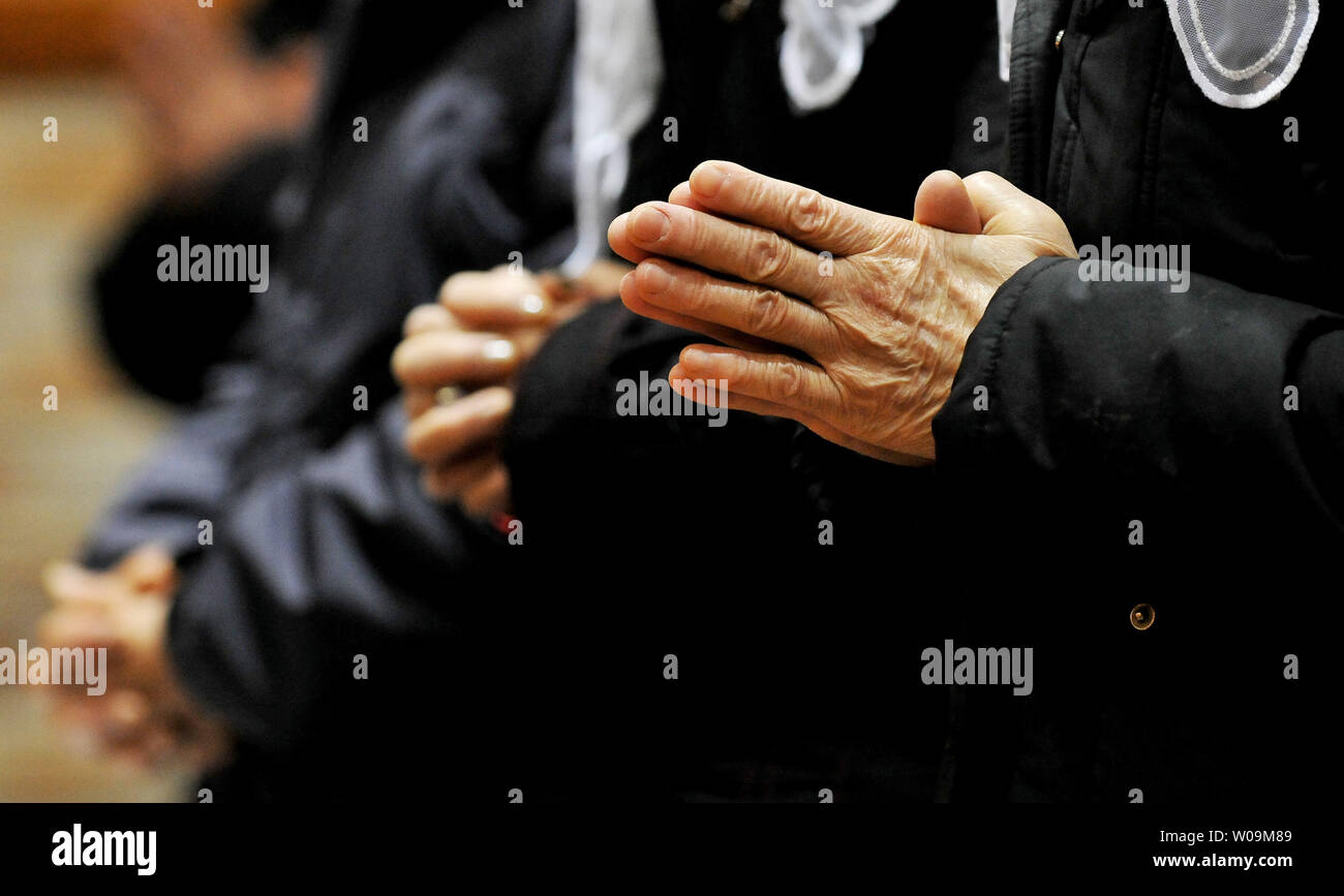 South Korean residents pray during Christmas mass on Yeonpyeong island ...