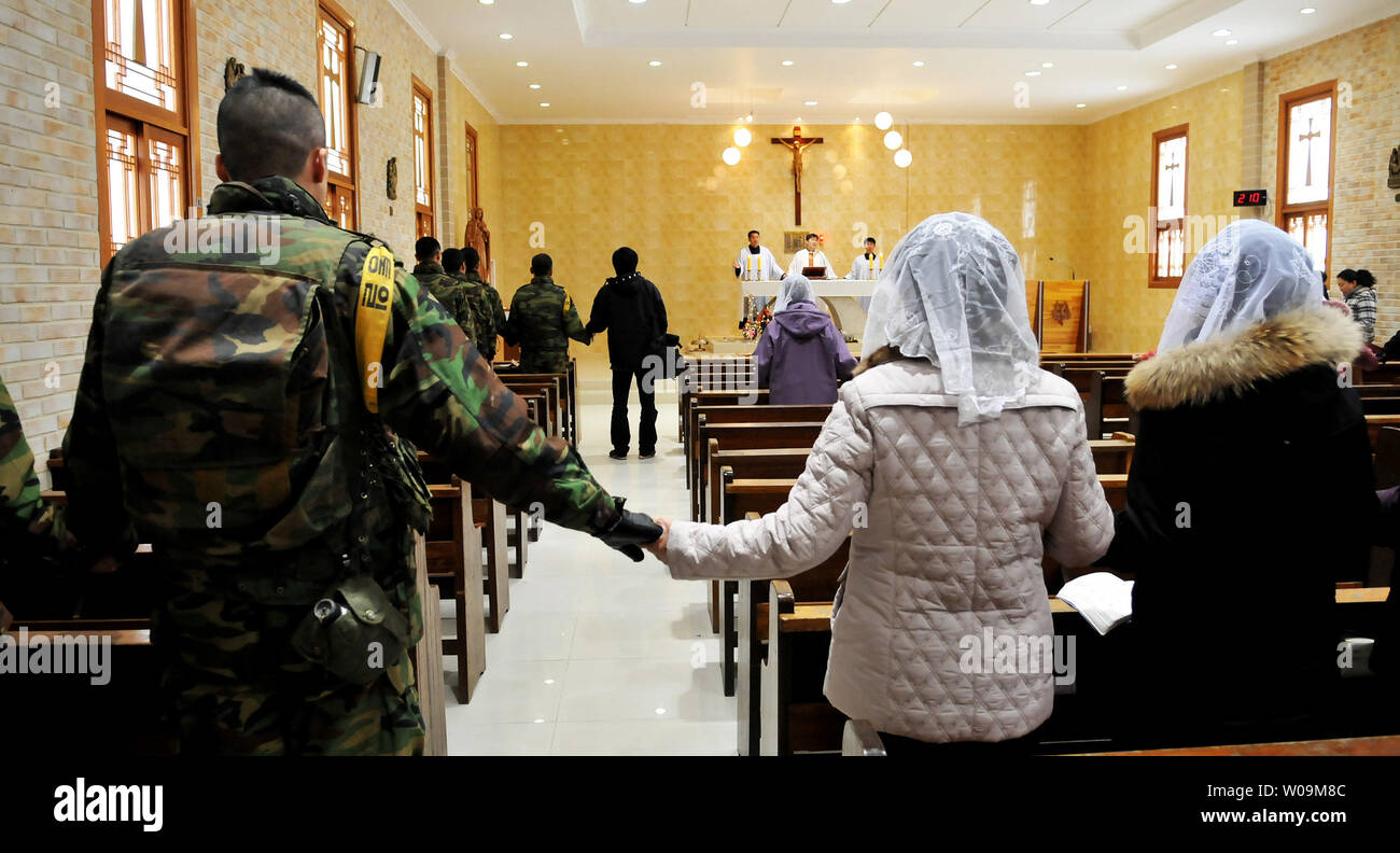 South Korean residents and marines pray during worship at church on ...