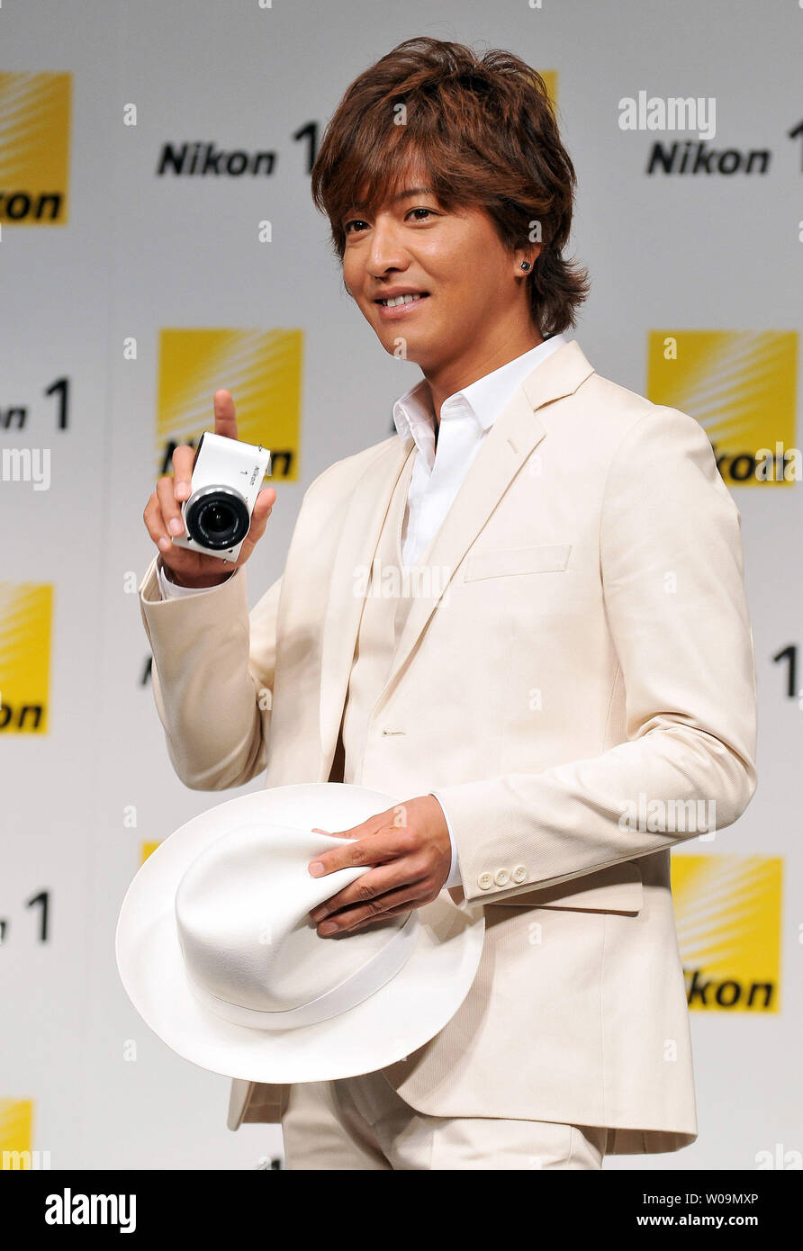 Japanese singer Takuya Kimura poses with new digital camera "Nikon 1 ...