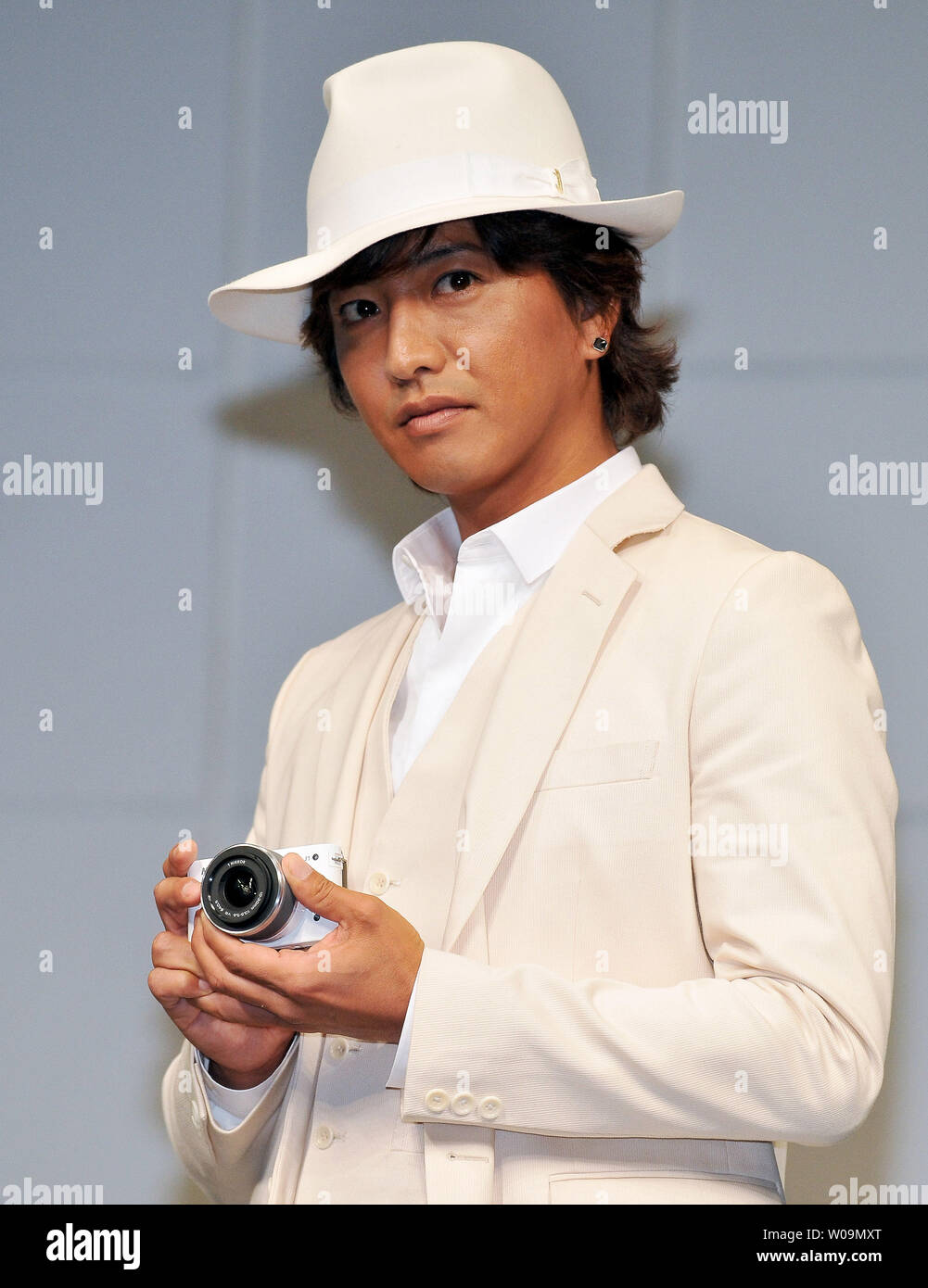 Japanese singer Takuya Kimura poses with new digital camera "Nikon 1 ...
