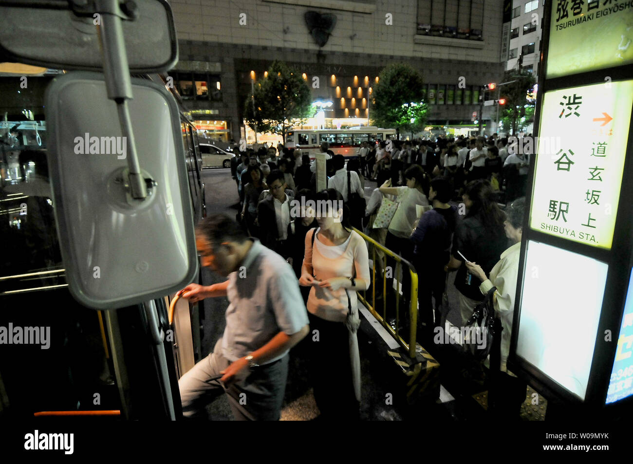 Passengers wait for the bus in front of Shibuya station in Tokyo, Japan ...