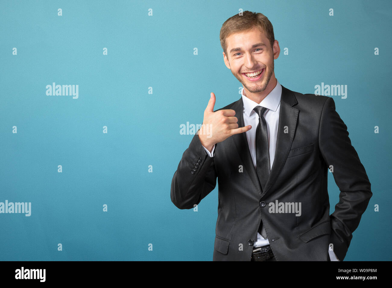 Young Businessman showing "Call me" sign Stock Photo - Alamy